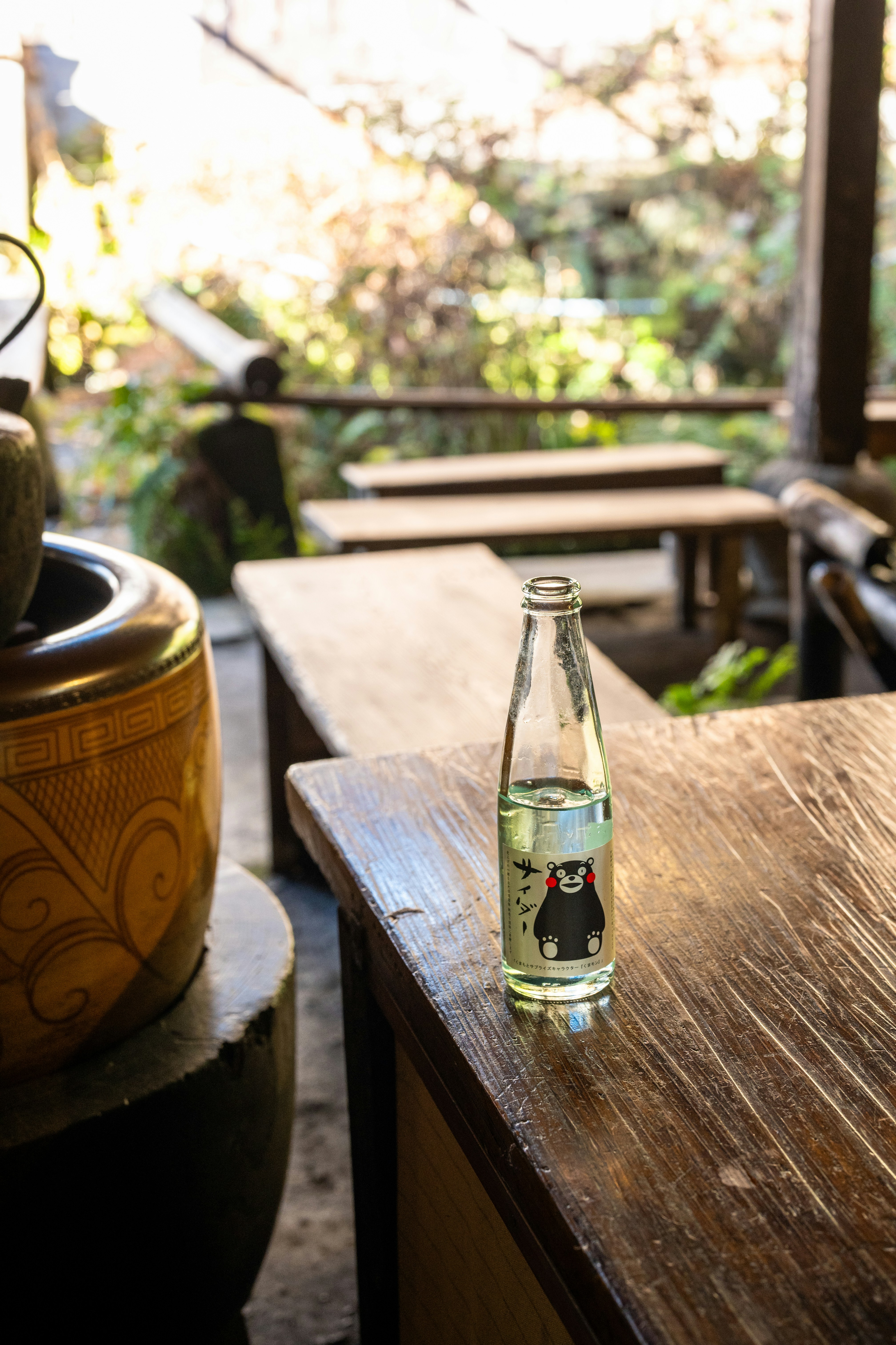 A bottle of water sitting on top of a wooden table