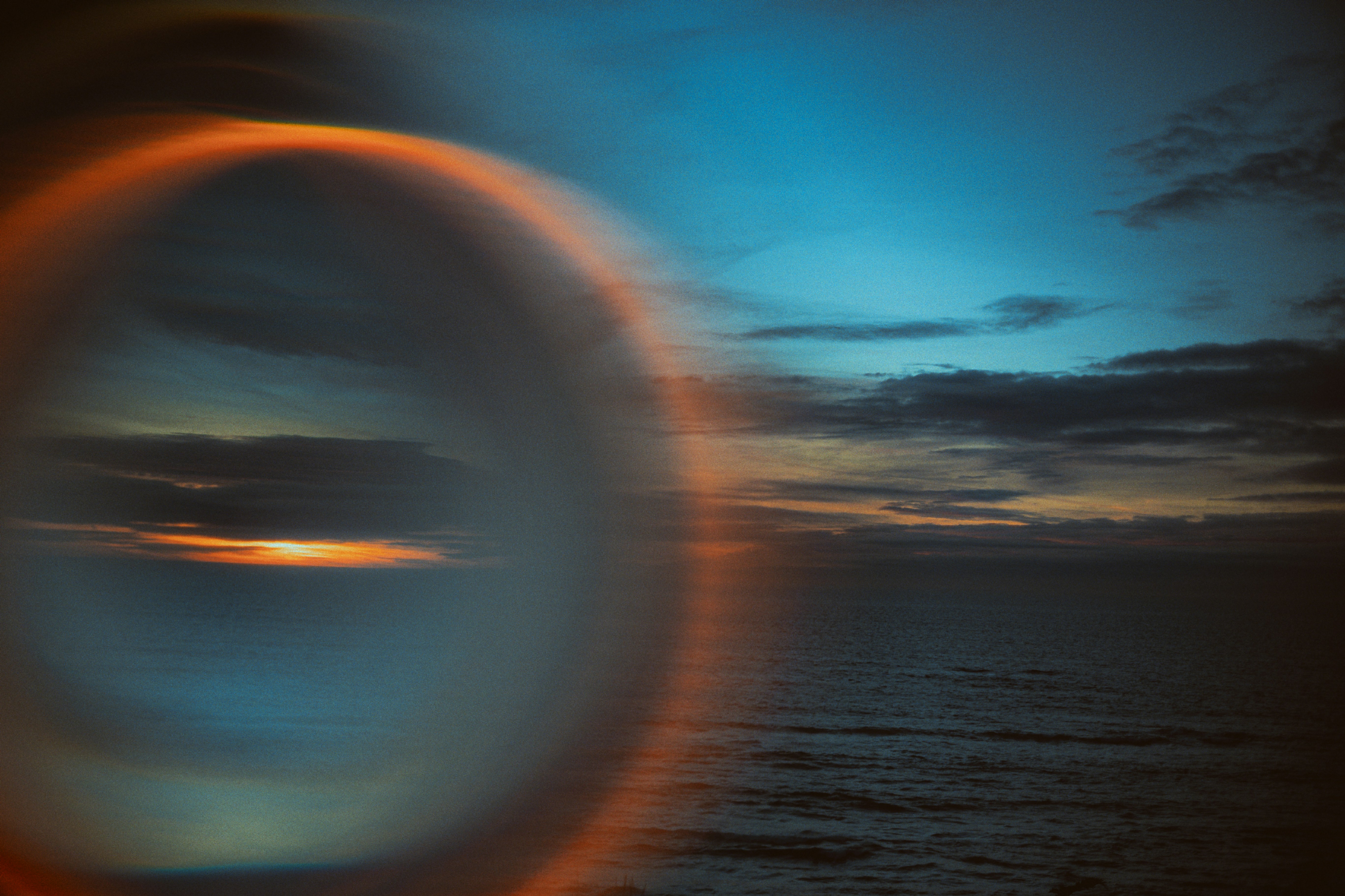 A blurry photo of a sunset over the ocean photo – Free Nature Image on ...