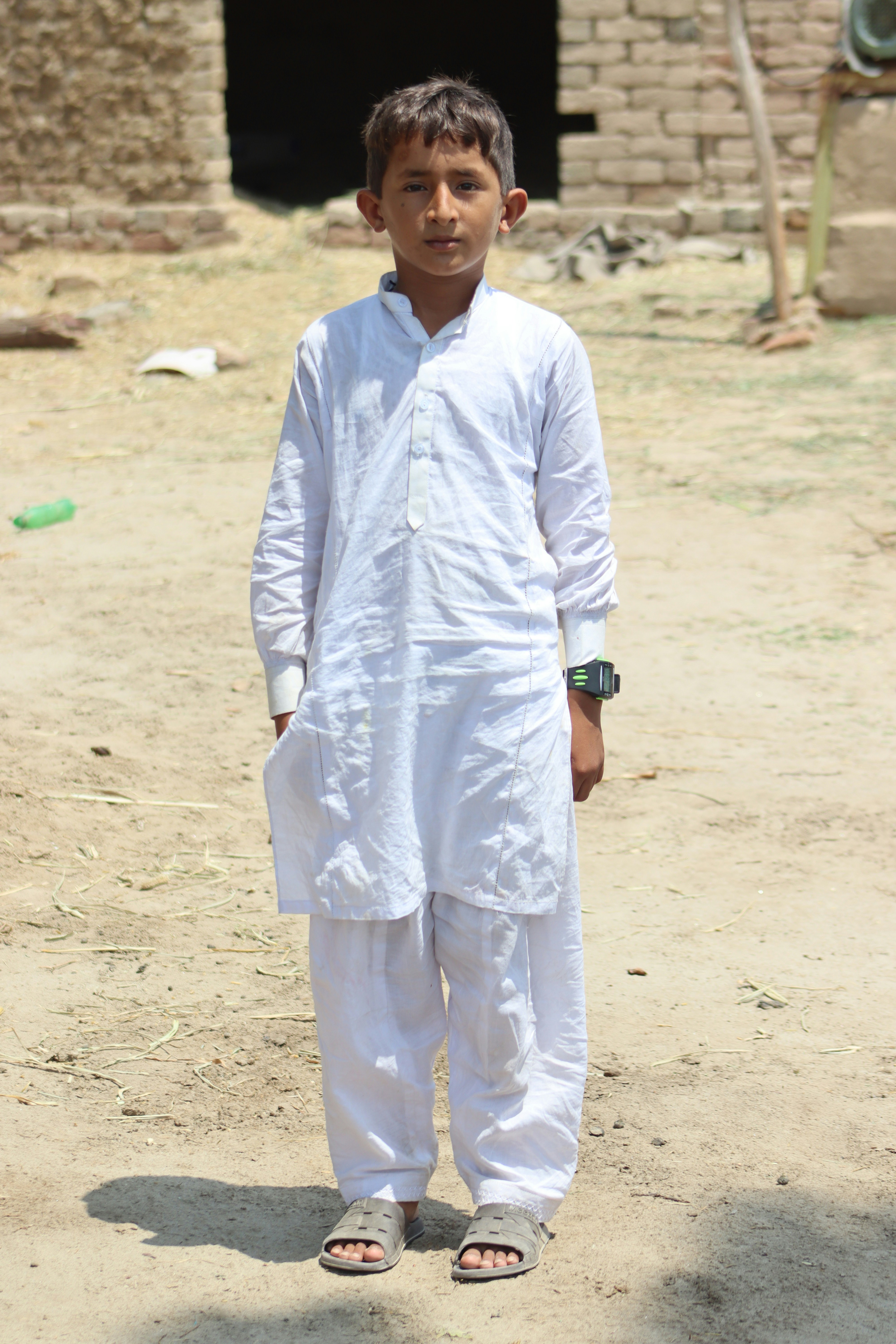 A young boy standing in front of a brick building photo – Free Human ...