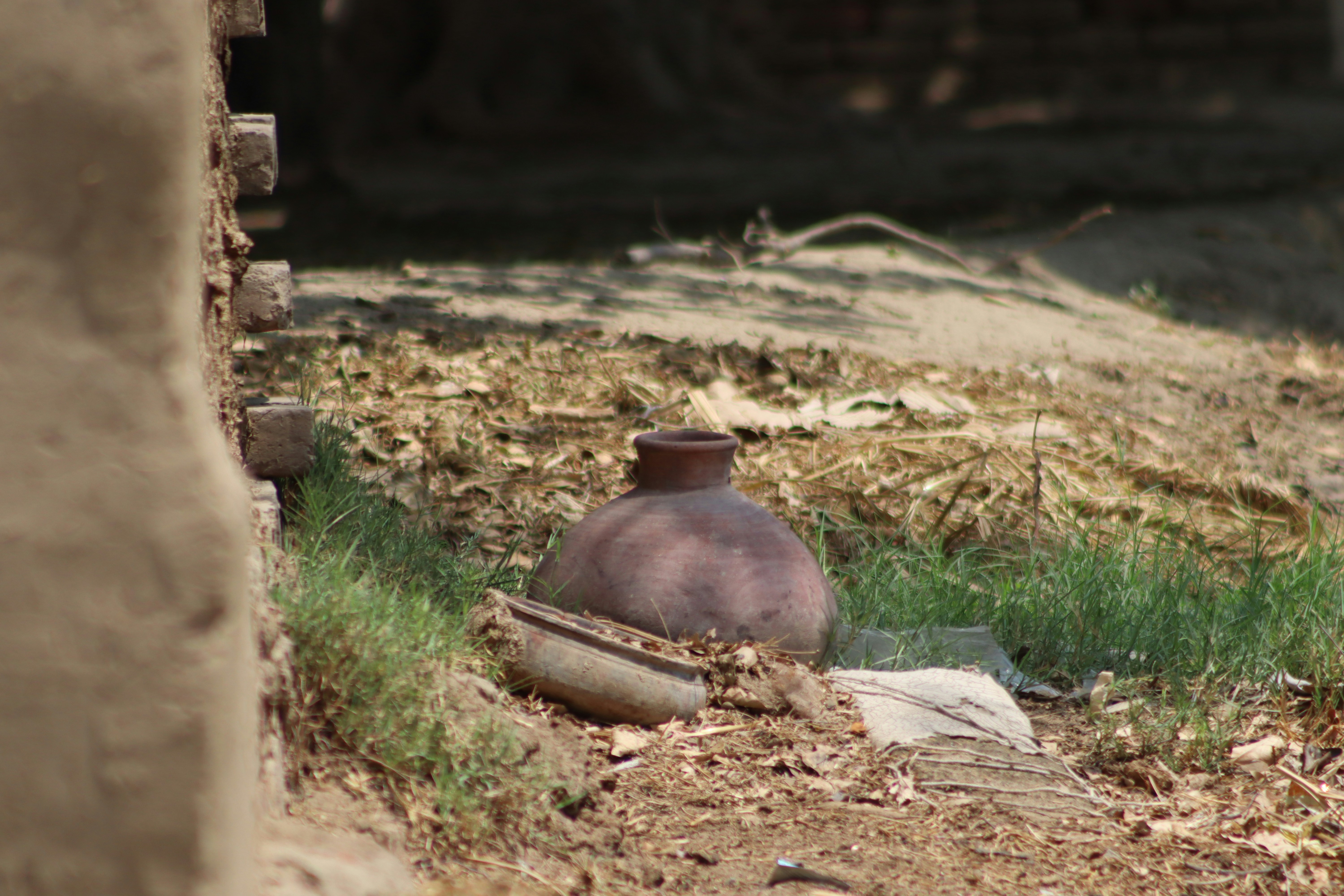 Weathered Earthen Jar Resting in a Dusty Courtyard