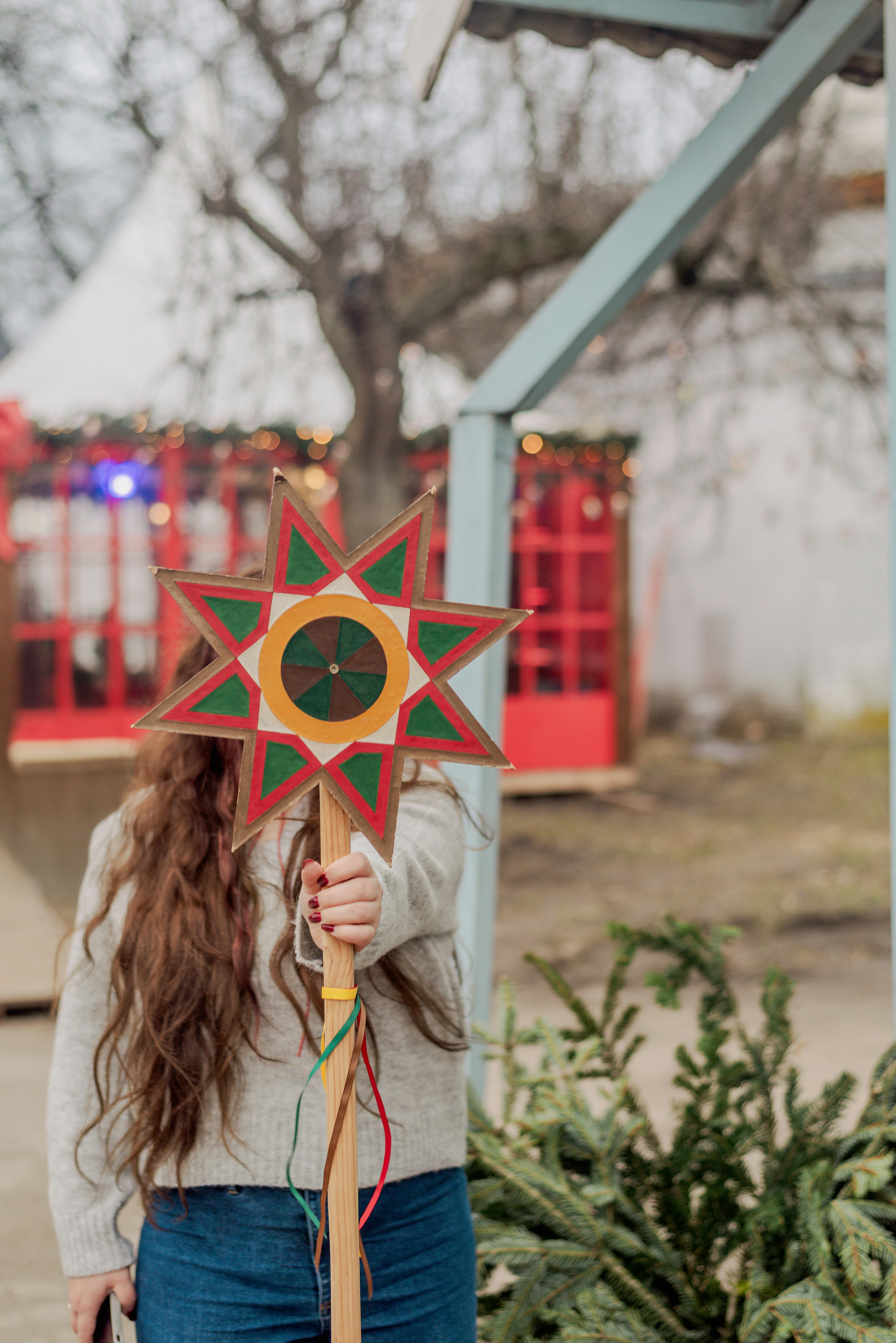 Star of Joy: A Child Holds a Festive Star in a Cozy Outdoor Scene