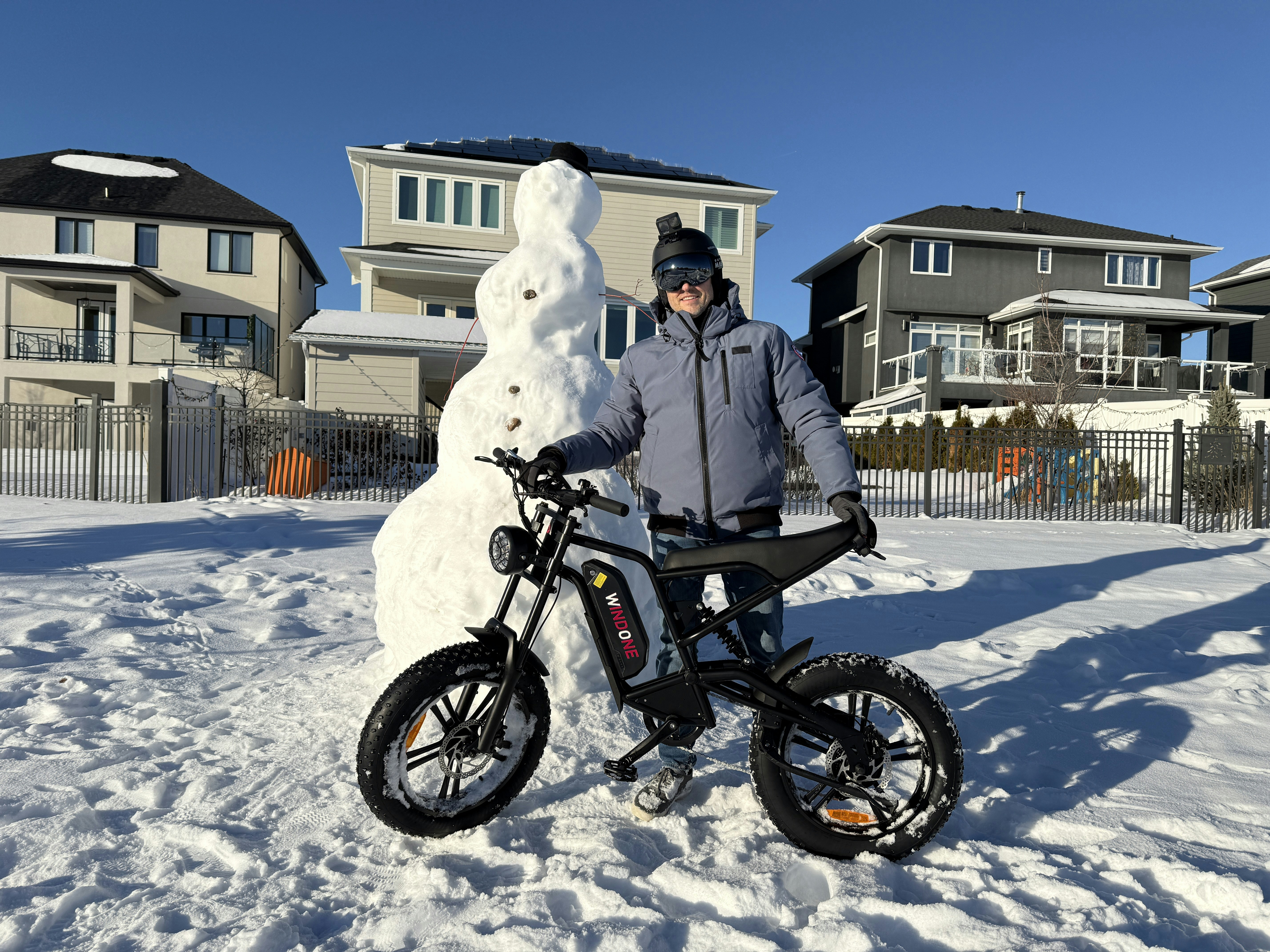 A man standing next to a snowman on a bike photo – Free Neighborhood ...