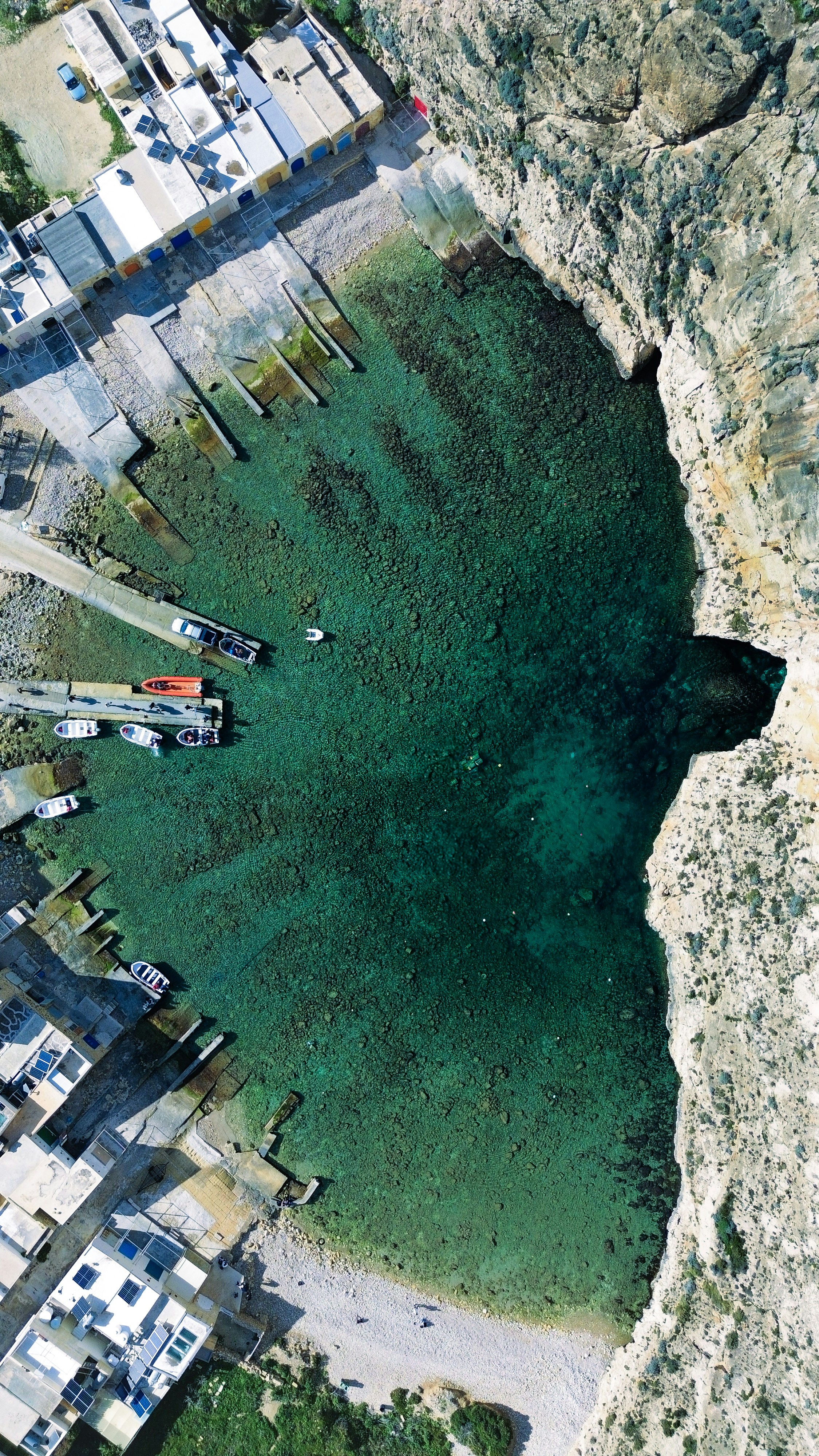 Emerald Quay: A Cliff-Sheltered Cove Fringed with Docks and Boats