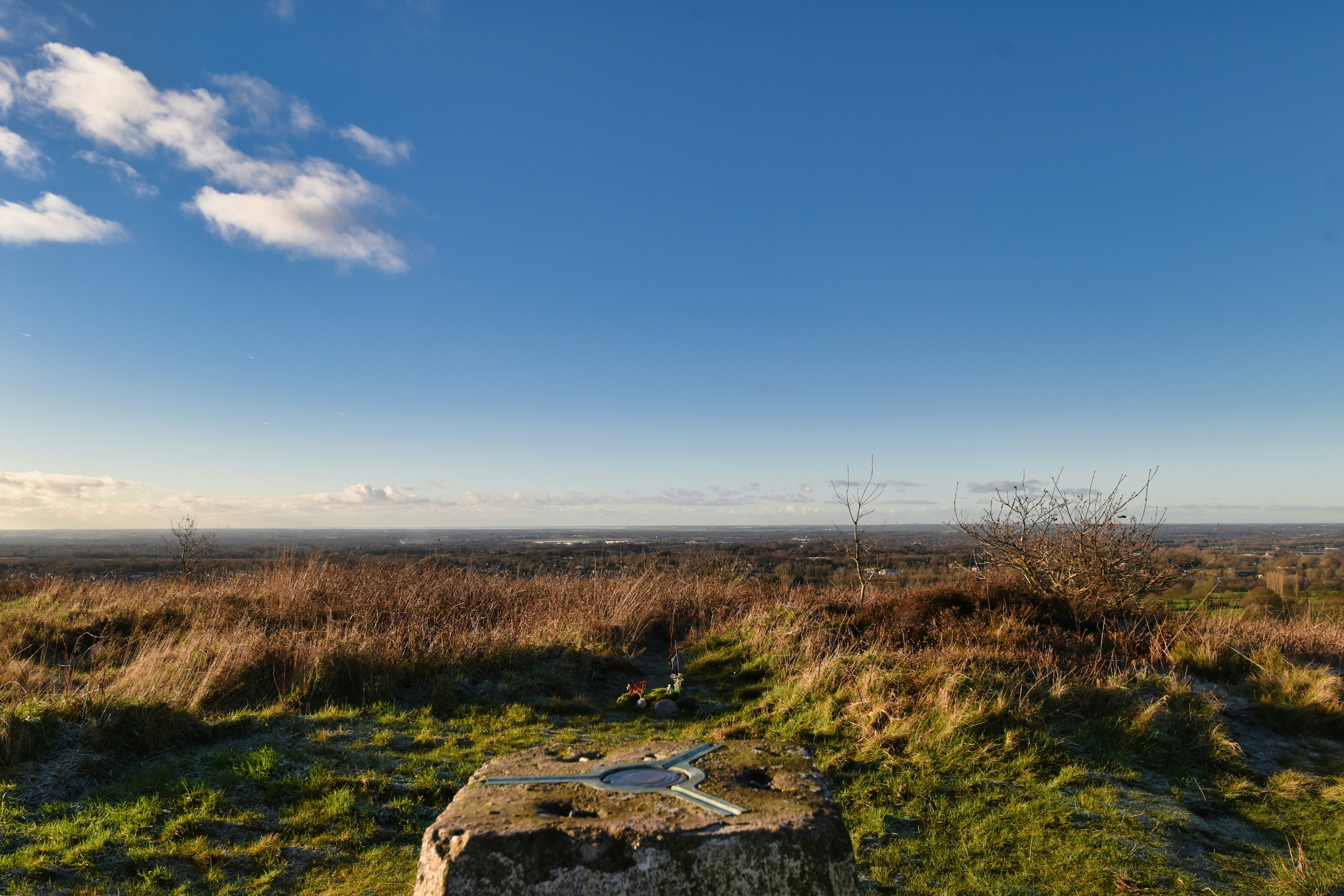 A large rock in a grassy field under a blue sky photo – Free Denham ...