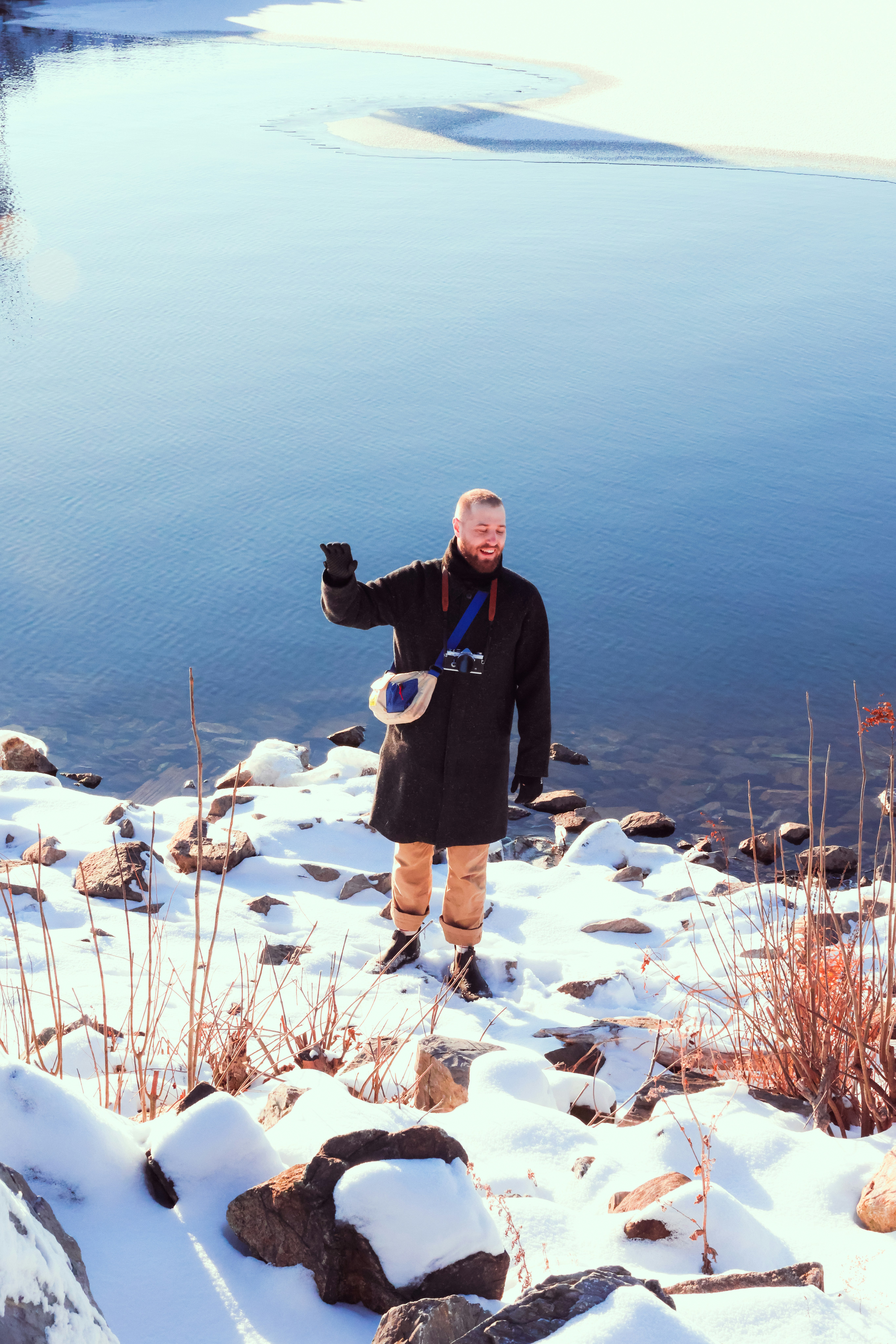 Waves of Winter: A Lone Traveler by the Icy Shore