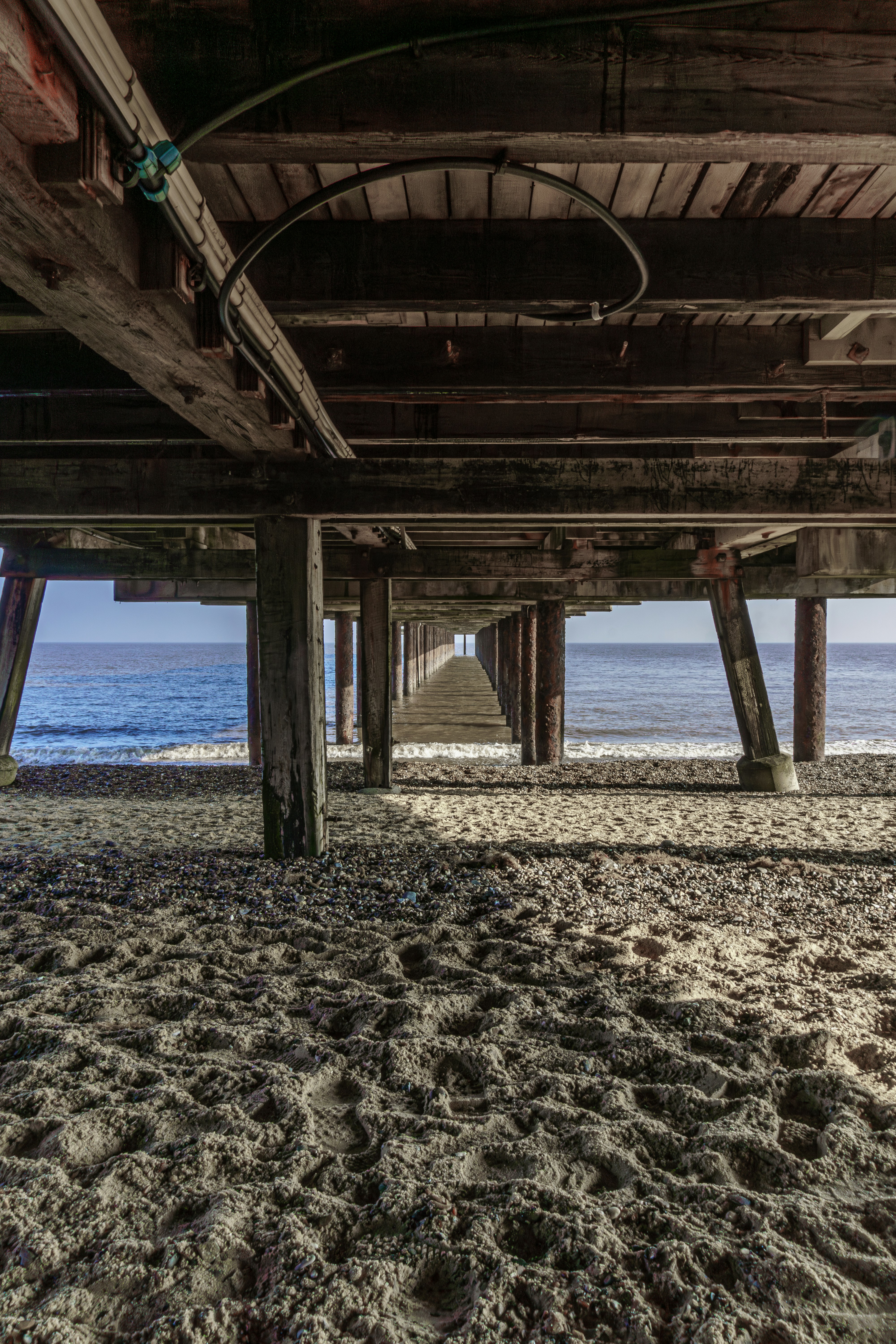 A view of the ocean from under a pier photo – Free Beach Image on Unsplash