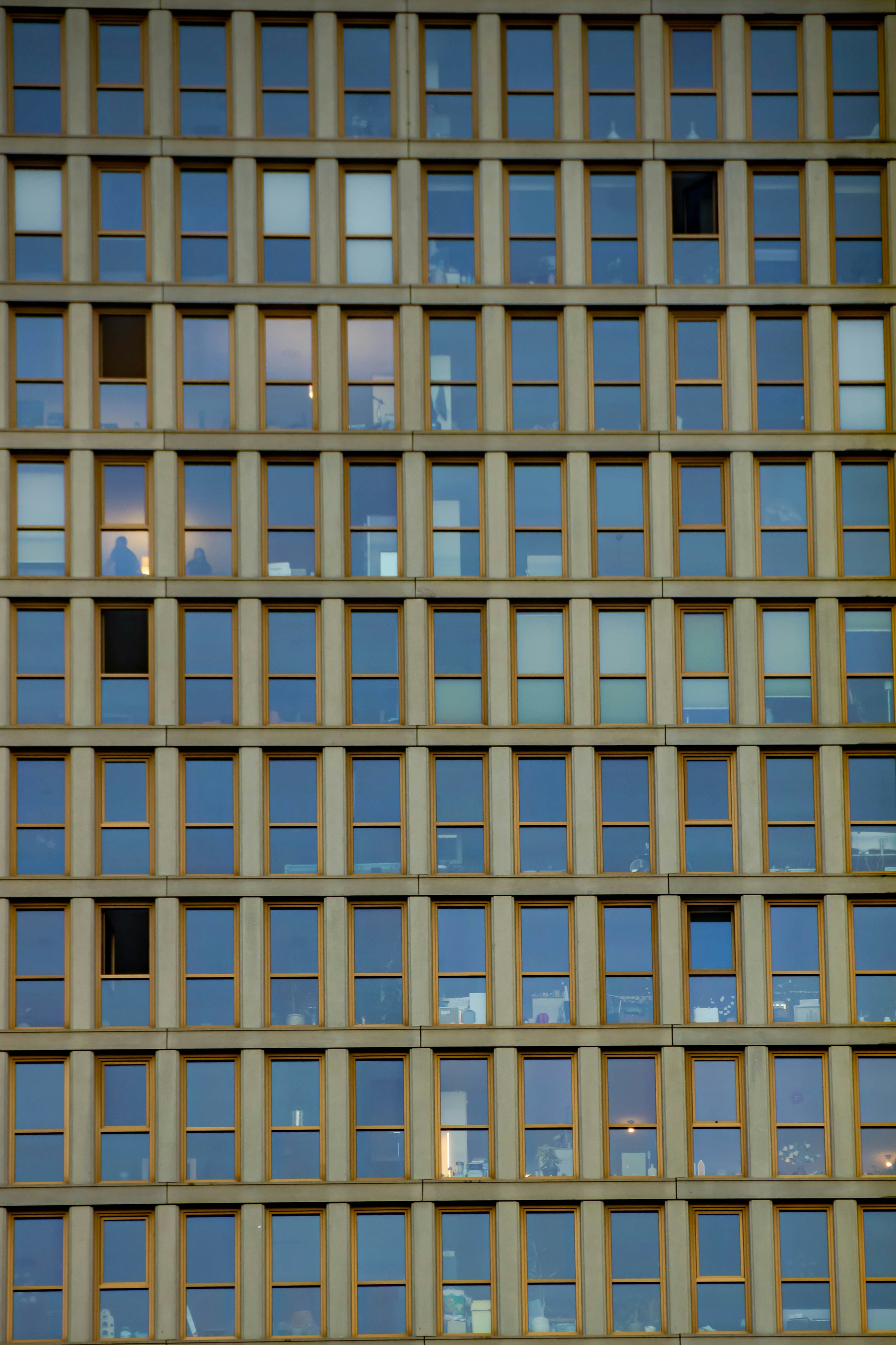 A large building with many windows and a stop sign photo – Free The ...