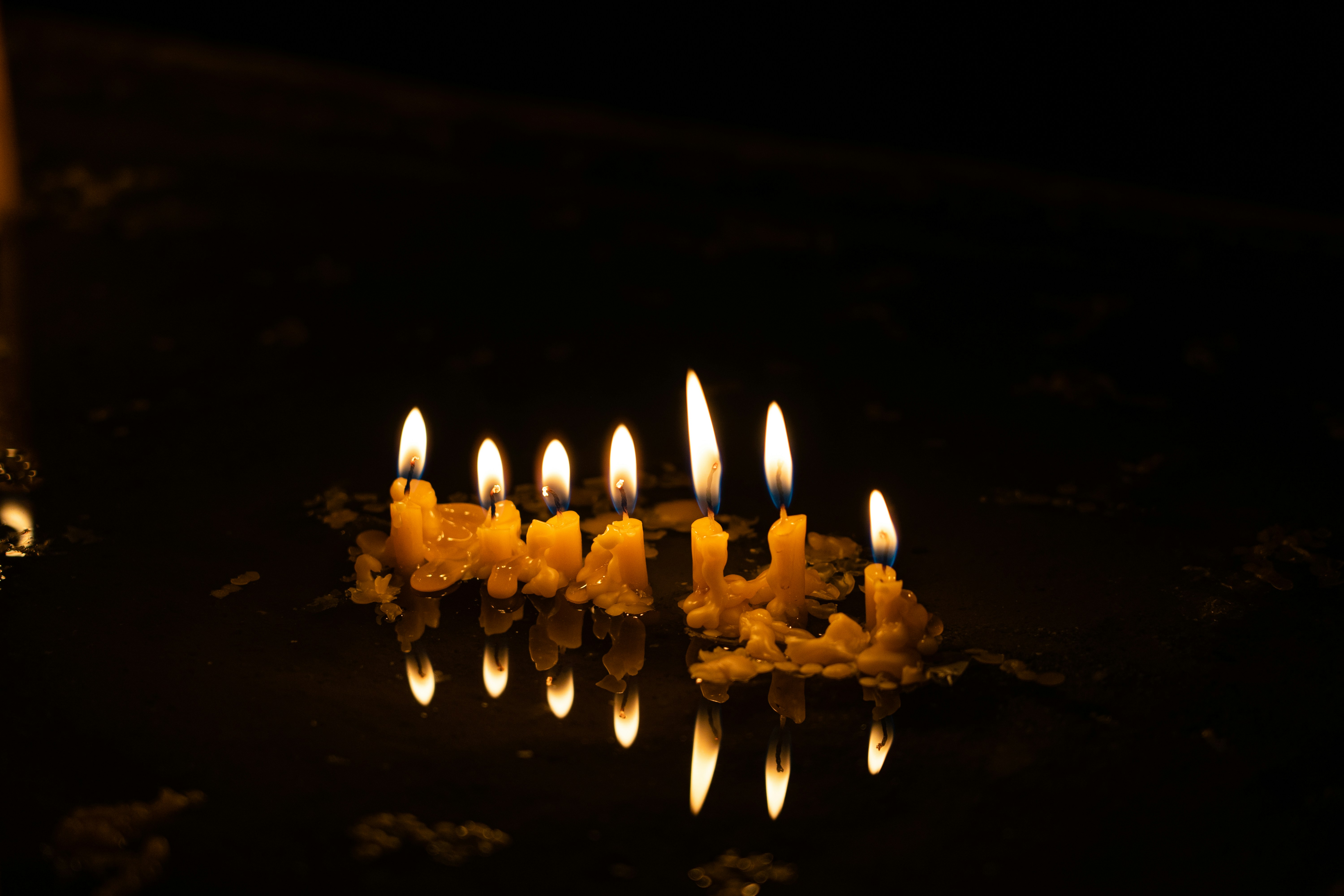 Row of Candle Flames and Quiet Reflections