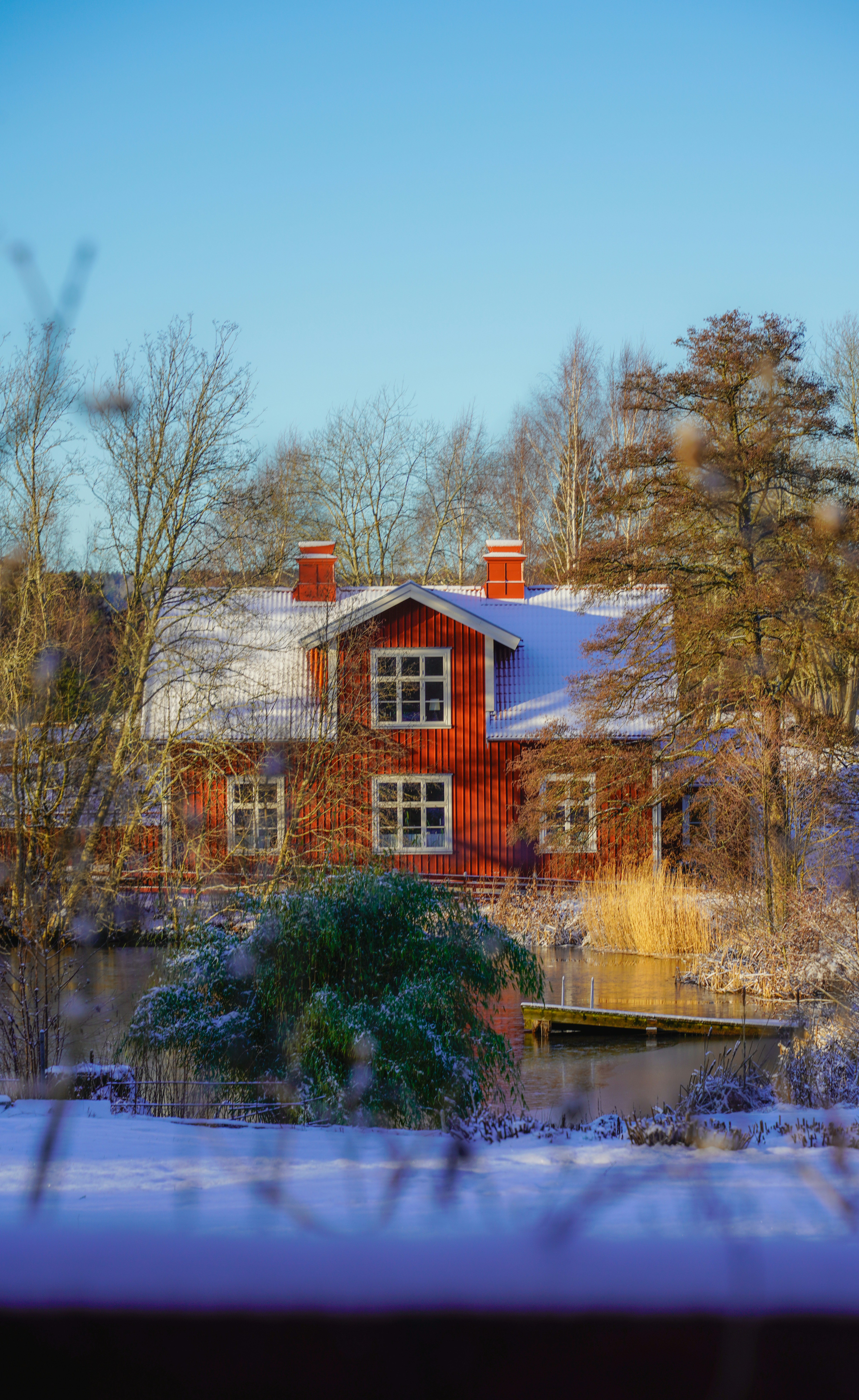 A red house in the middle of a snowy field photo – Free Nature Image on ...