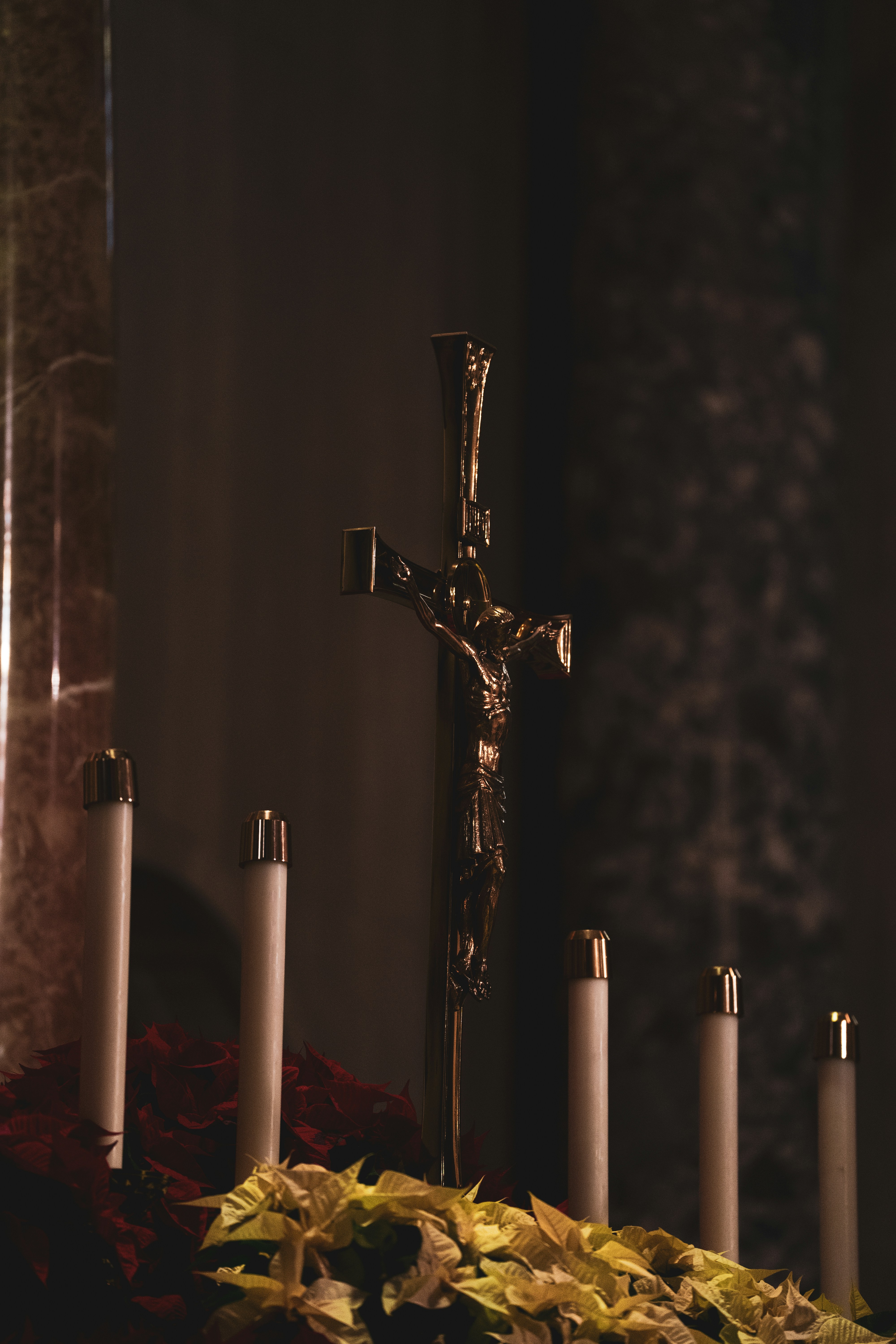 A cross and a bunch of candles in a church photo – Free Cross Image on ...