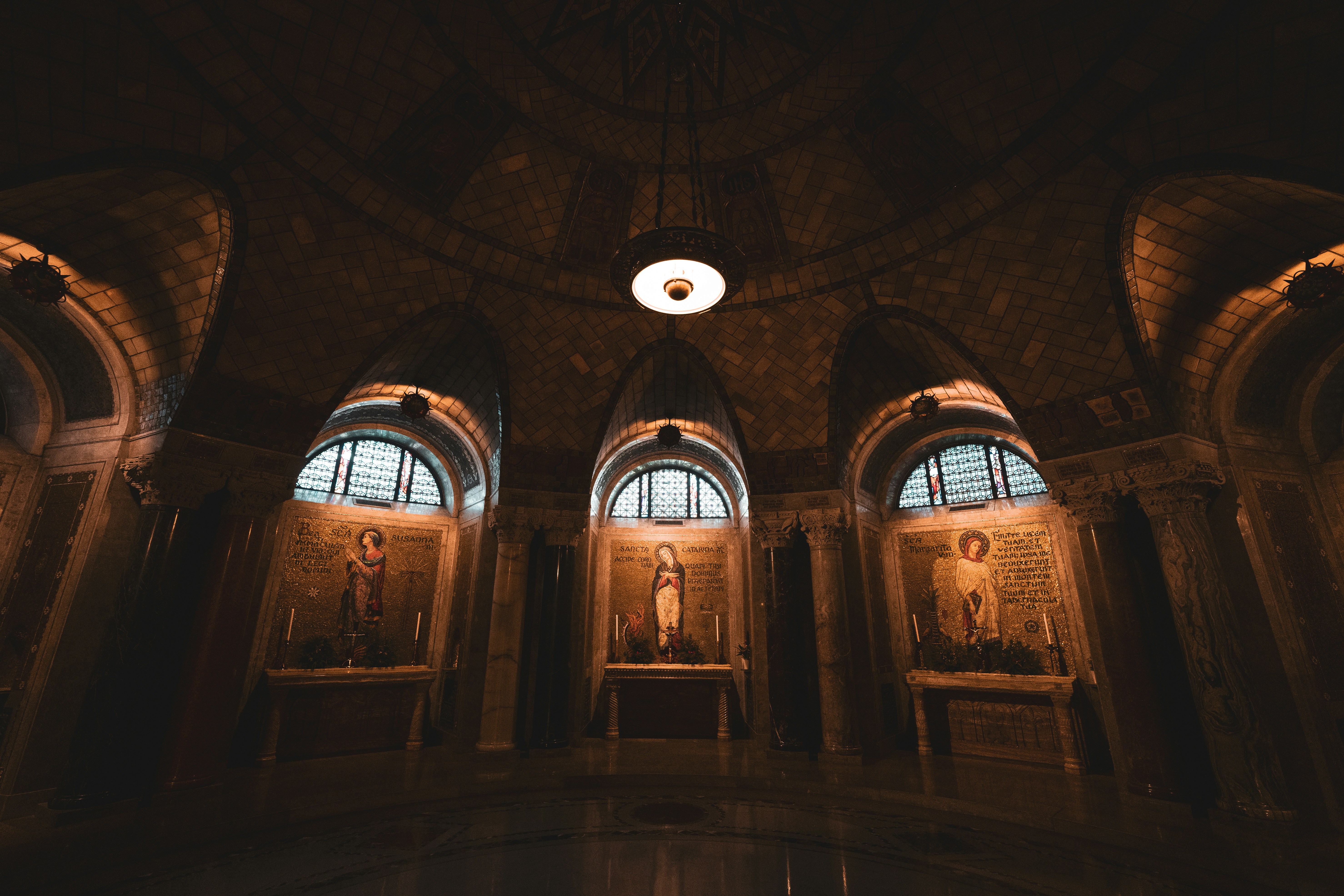 A large room with arched windows and a clock on the wall