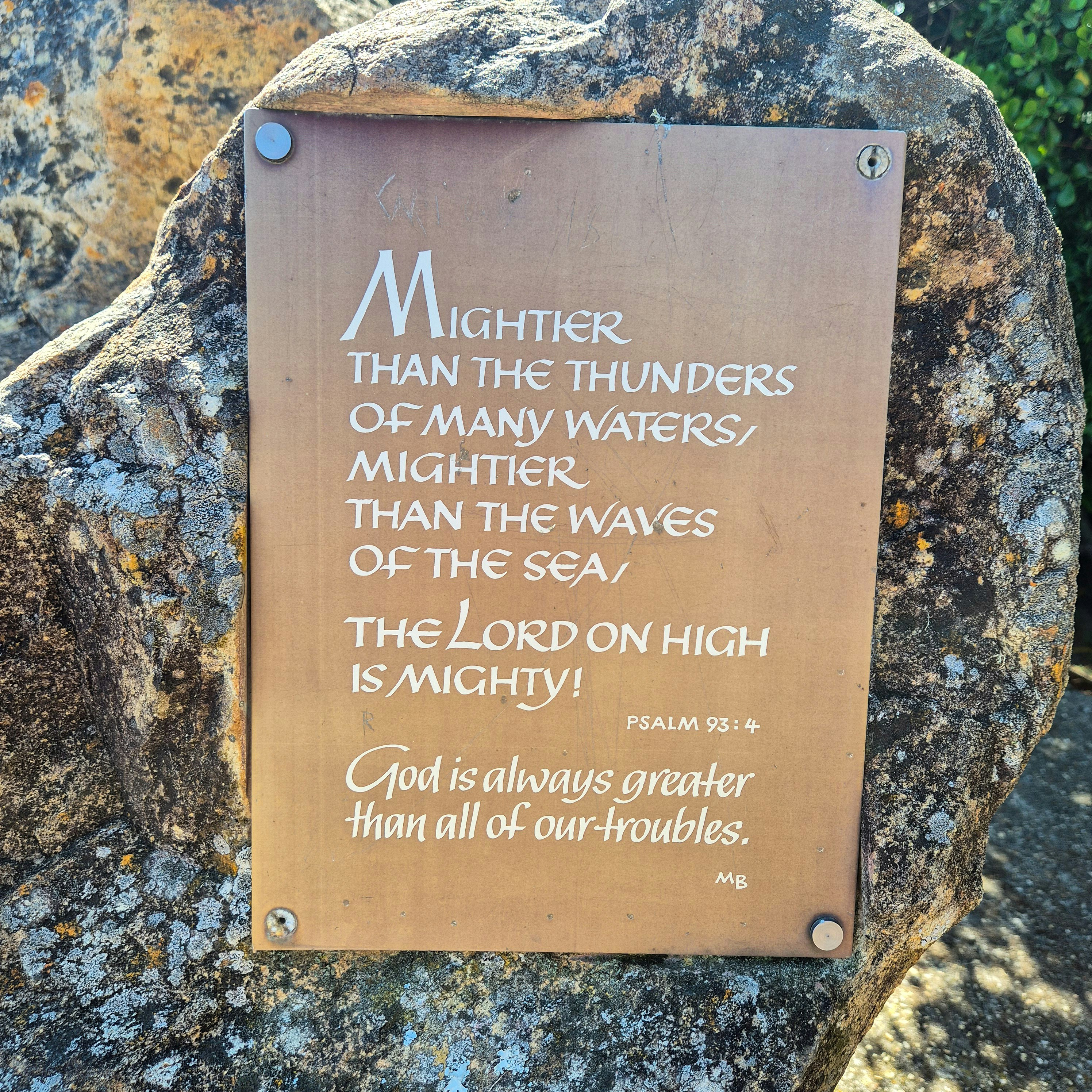 A plaque on a rock with a poem written on it