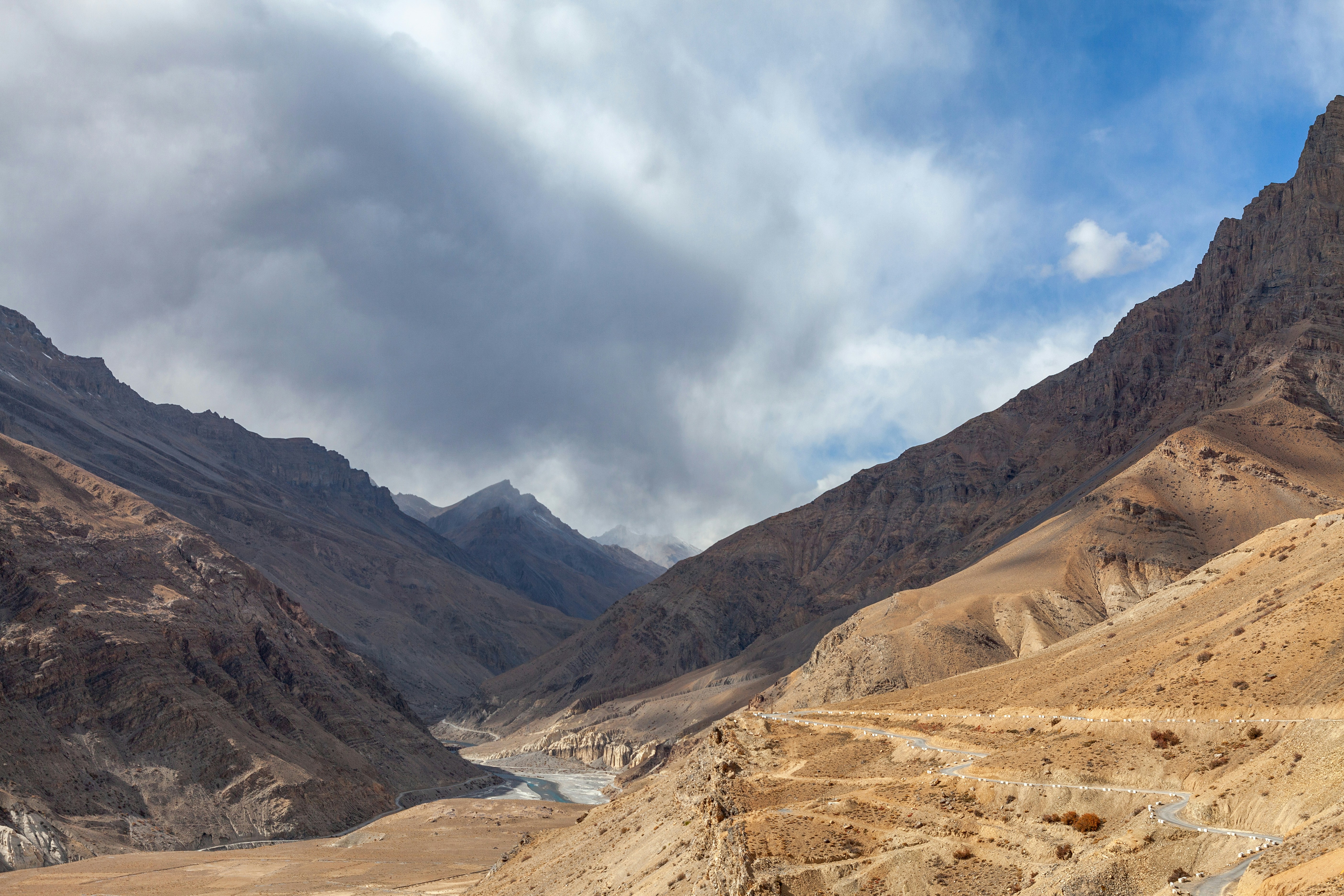 A view of a valley with mountains in the background photo – Free Spiti ...