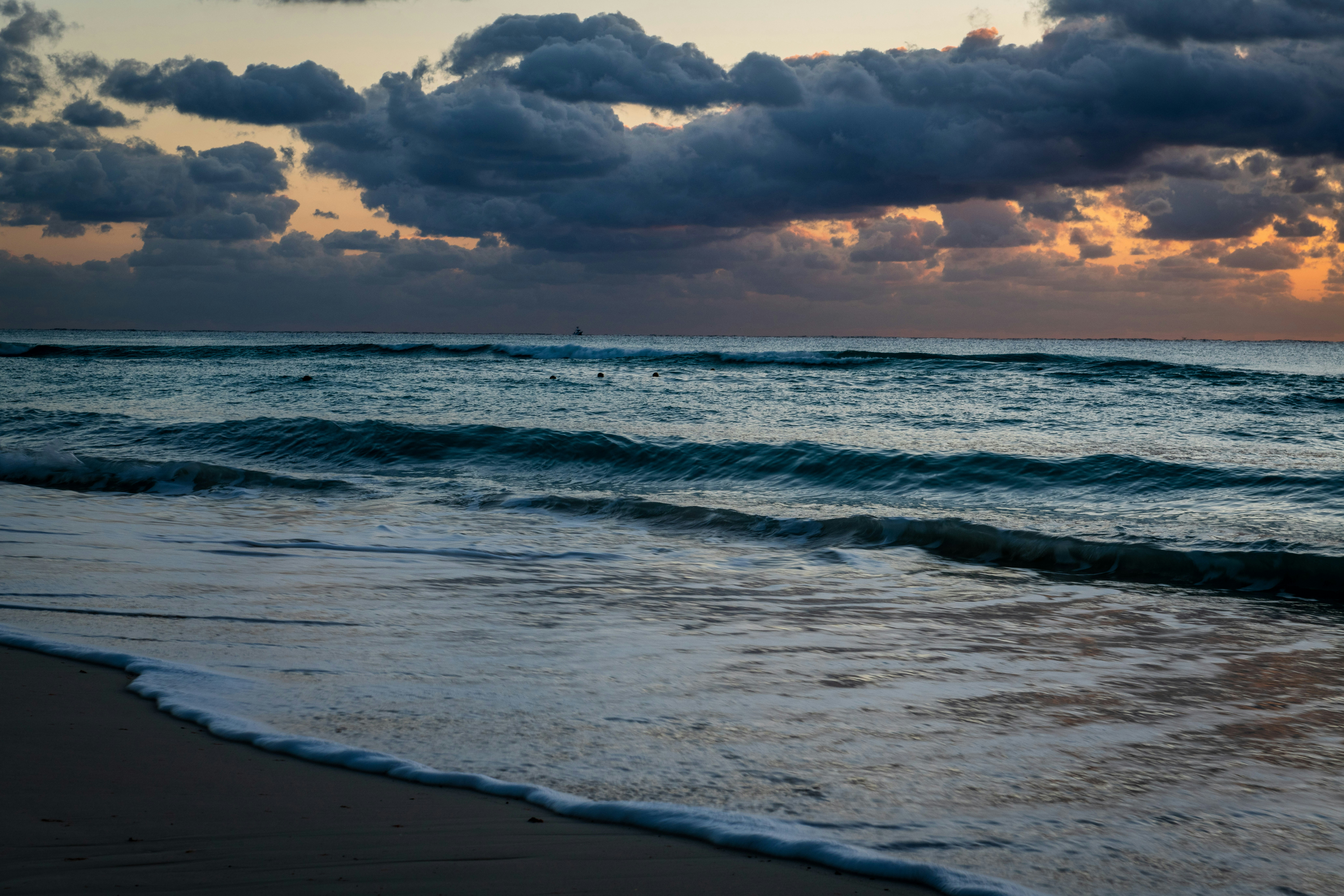 A beach with waves coming in to the shore photo – Free Horizon Image on ...