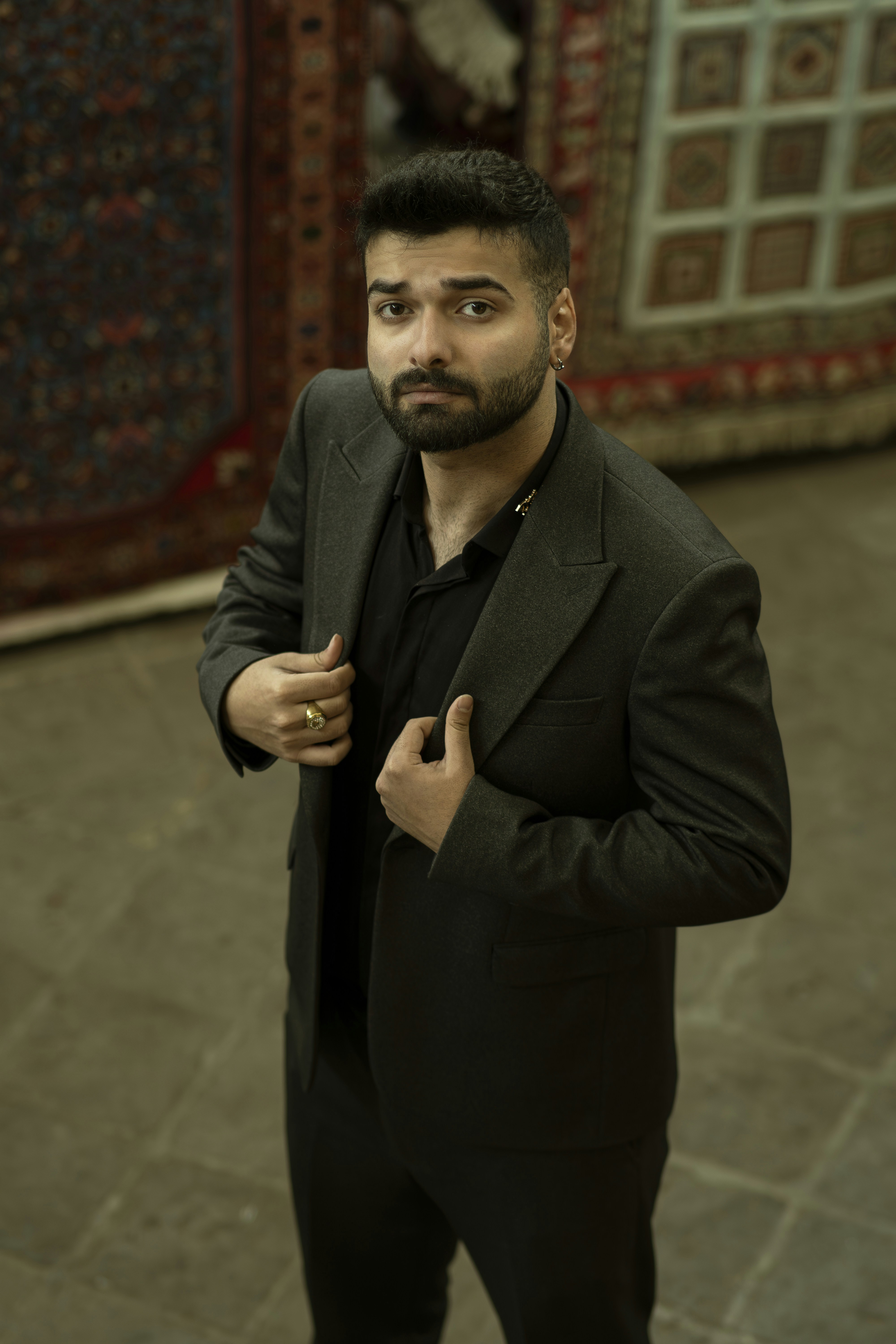 Gentleman in a charcoal blazer commands the frame
