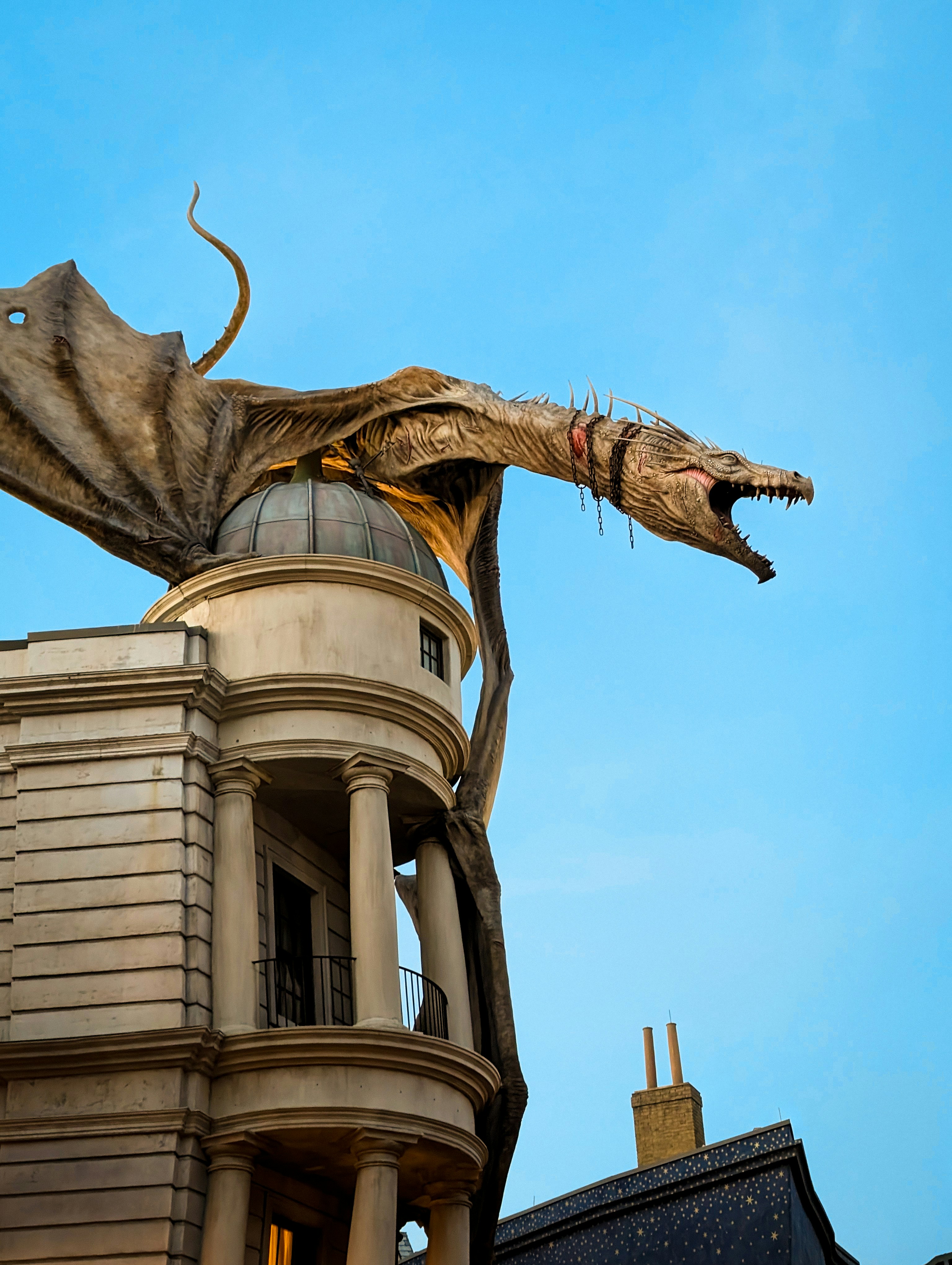 A statue of a dragon on top of a building photo – Free Orlando Image on ...