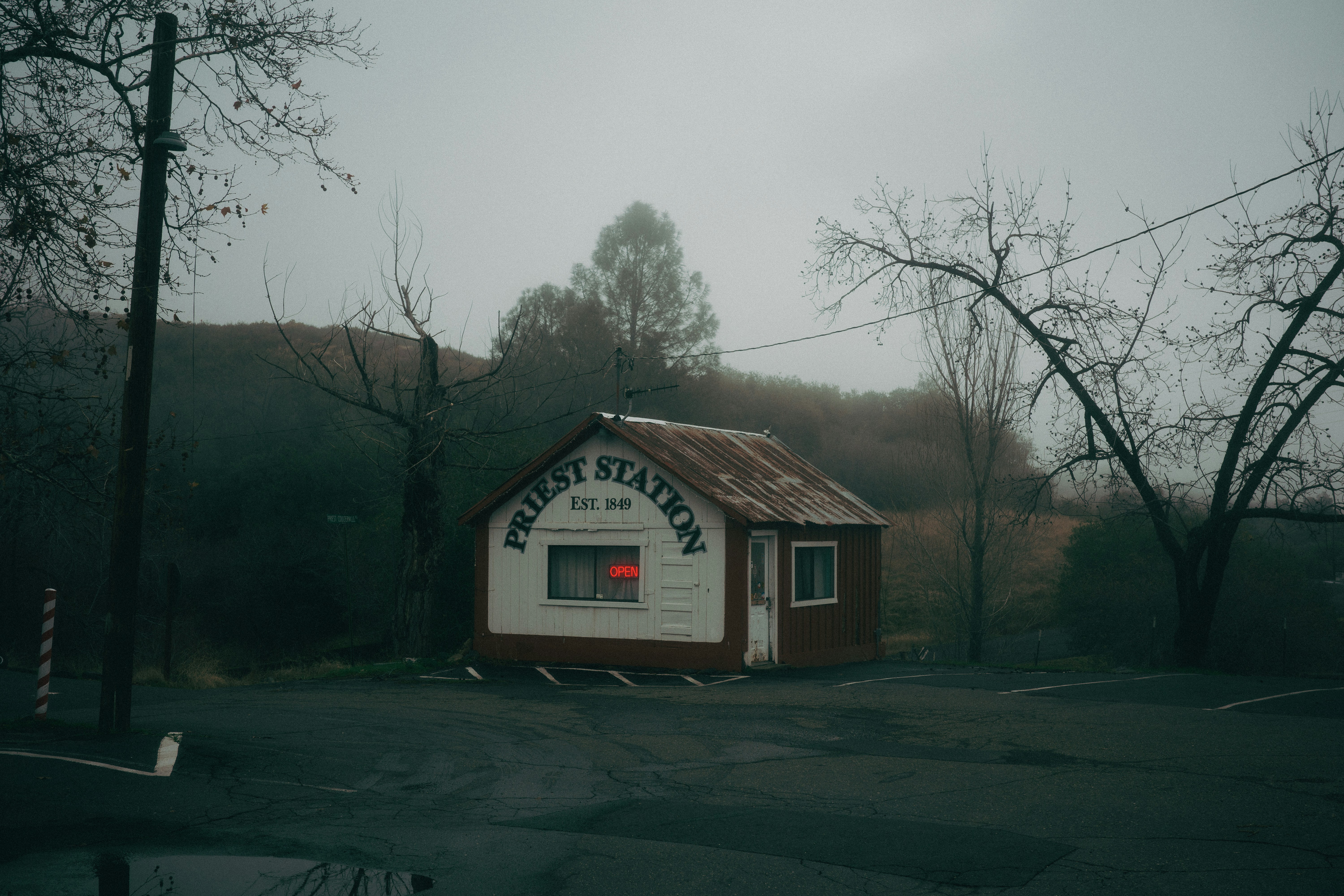 A small red and white building sitting on the side of a road photo ...