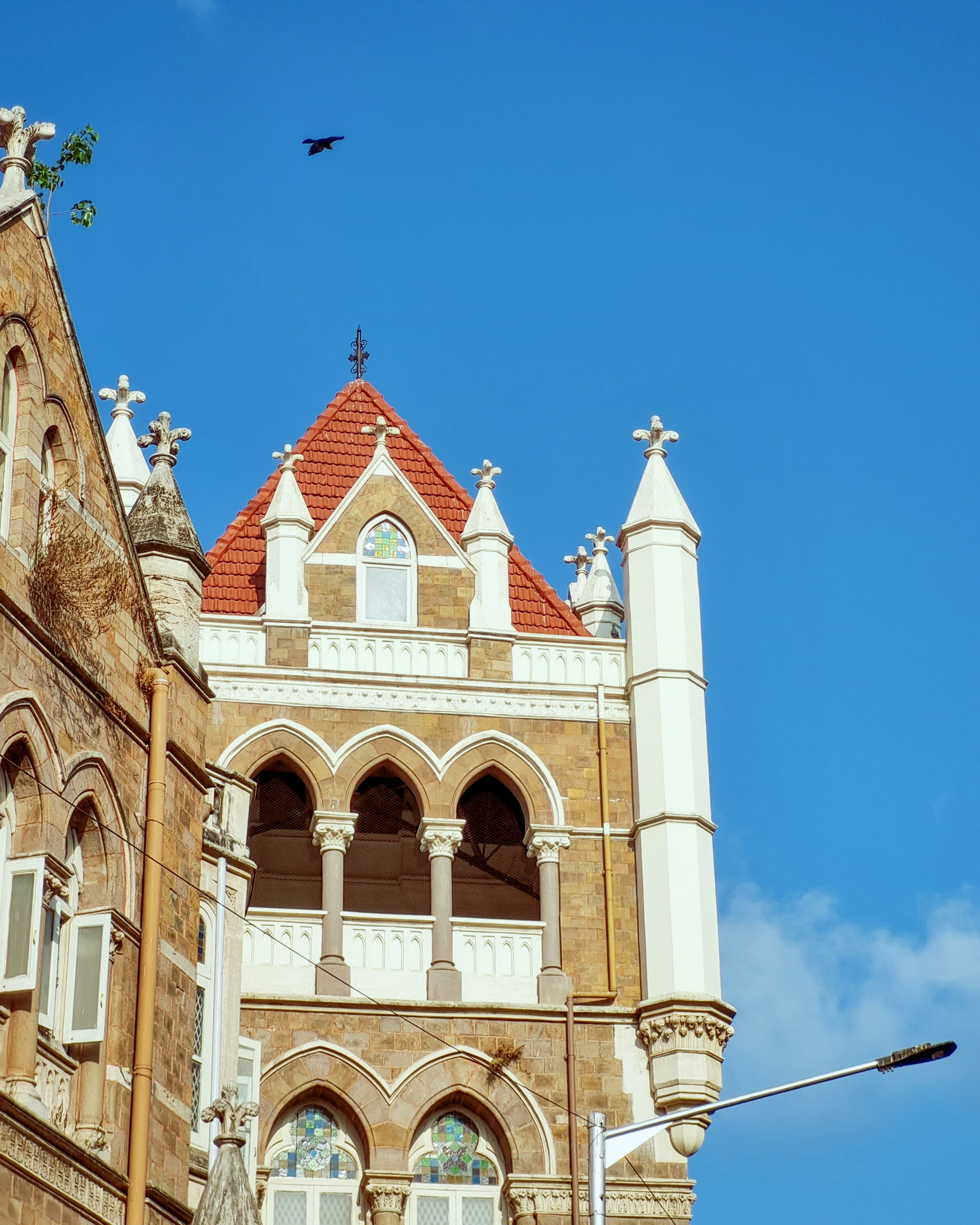 Blue-Sky Gothic: Arched Facade and Red Roofs