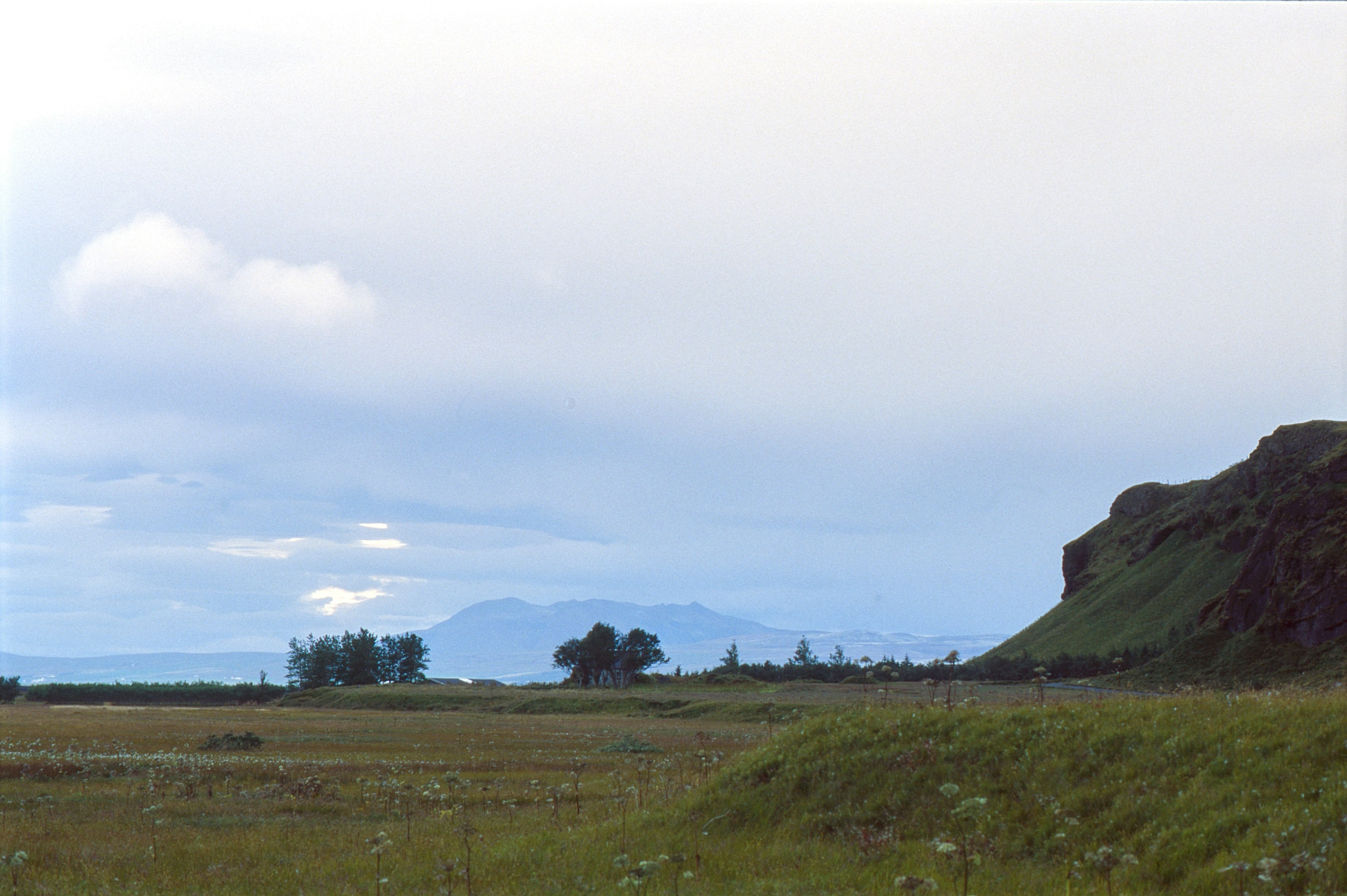 A grassy field with a hill in the background photo – Free Iceland Image ...