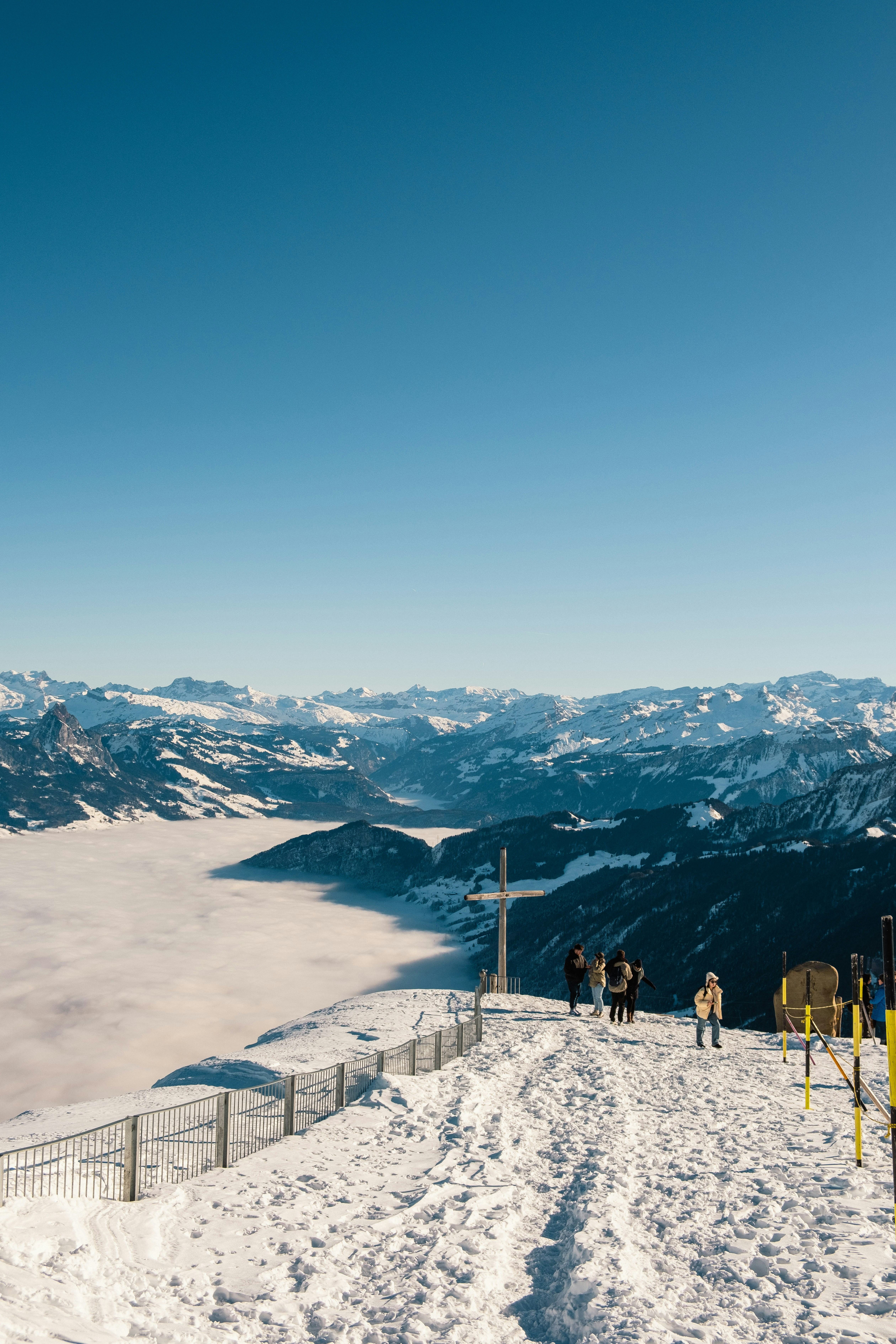 A group of people standing on top of a snow covered slope photo – Free ...