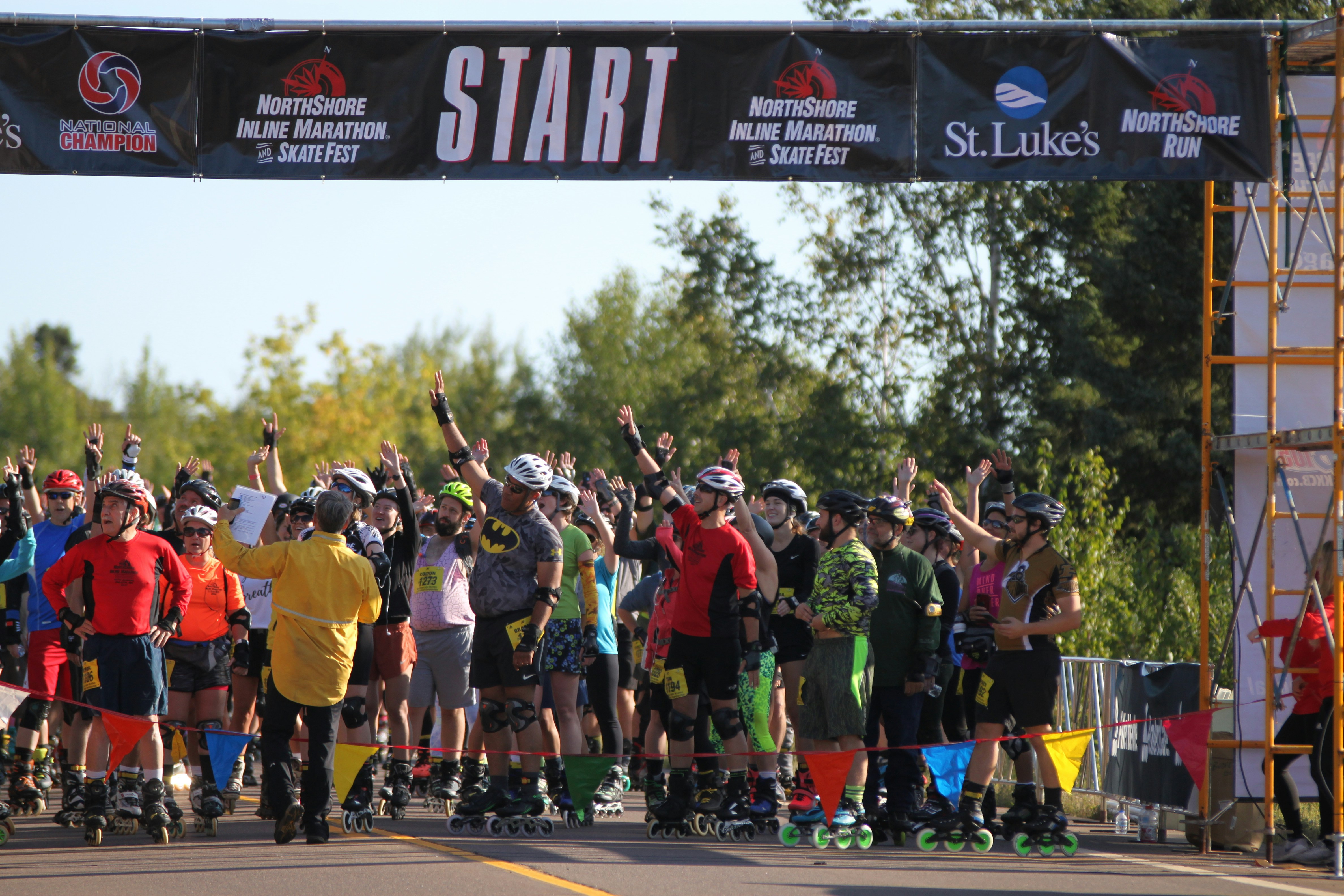 A group of people riding skateboards down a street photo – Free Duluth ...
