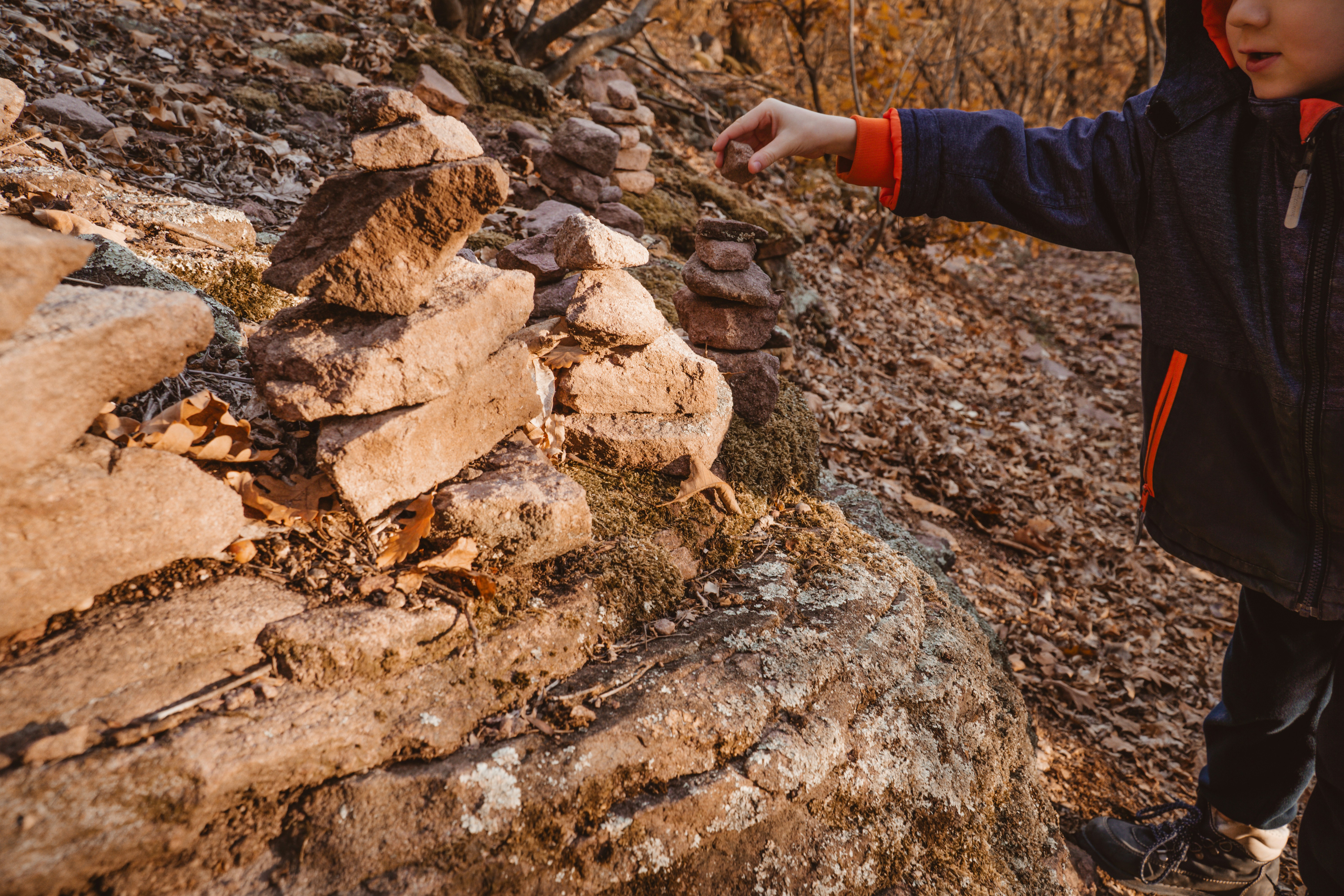 A young boy pointing at a rock formation photo – Free Kid Image on Unsplash