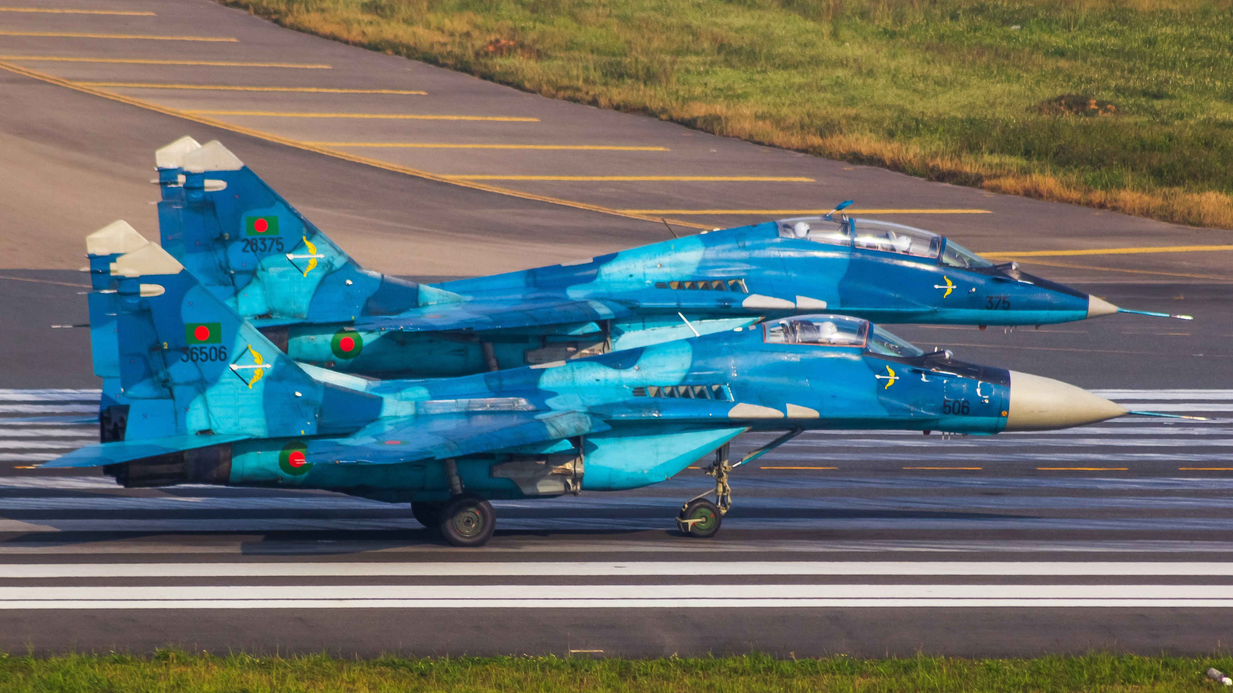 A blue fighter jet sitting on top of an airport runway photo – Free ...