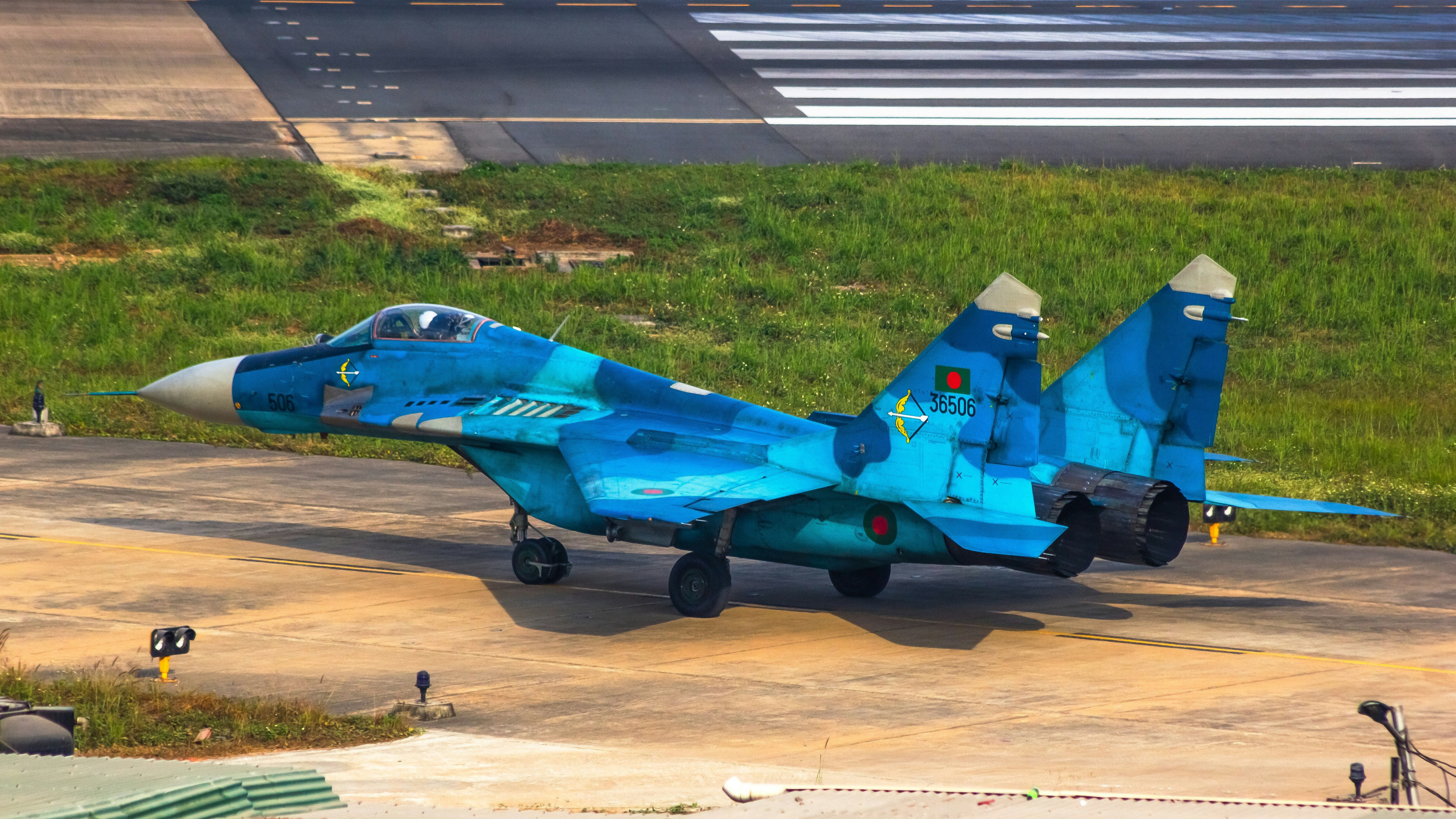 Azure Thunder on the Tarmac: a cobalt-blue fighter parked under noon sun