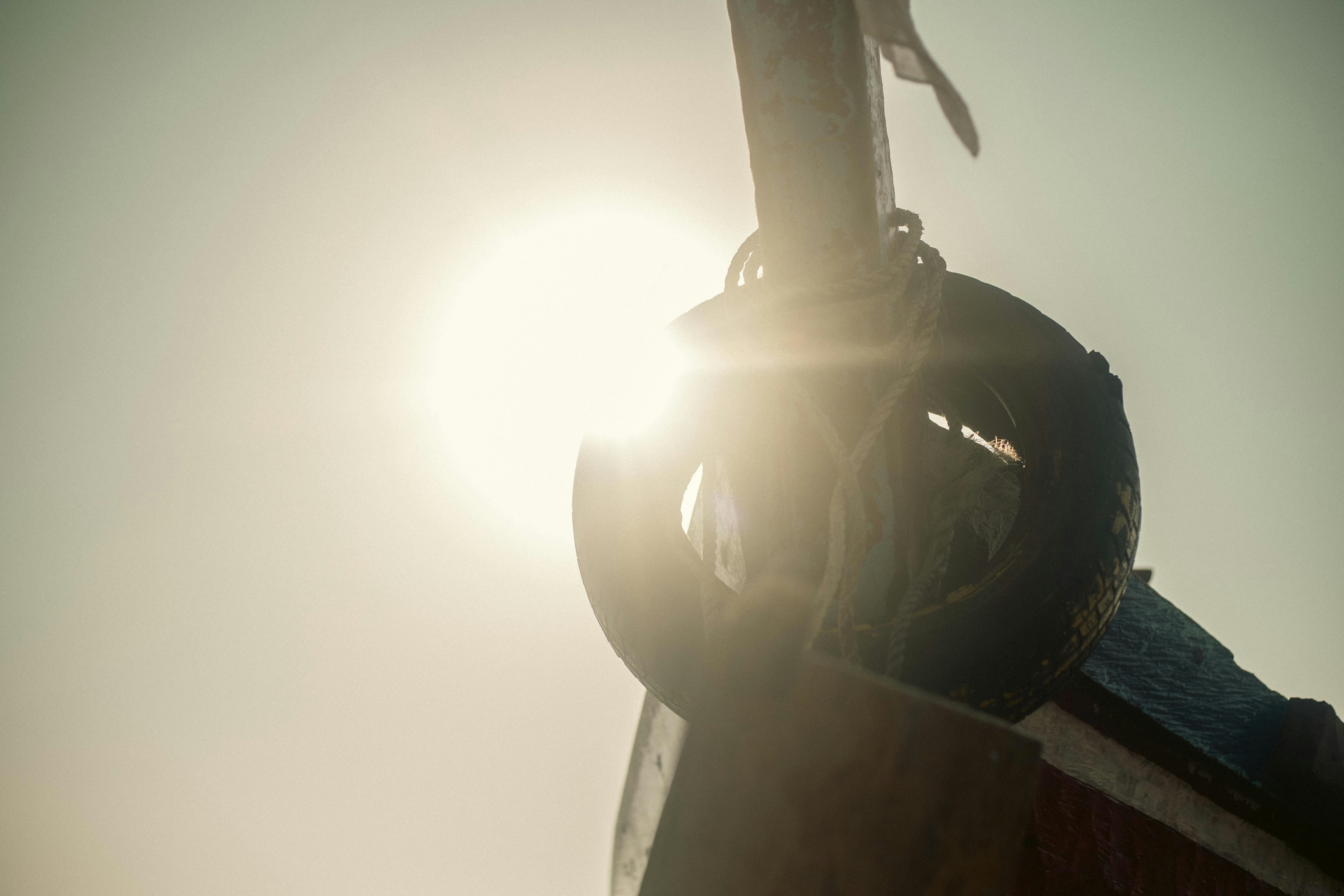 Sunlit Padlock on a Weathered Rail: A Quiet Moment of Steel and Light