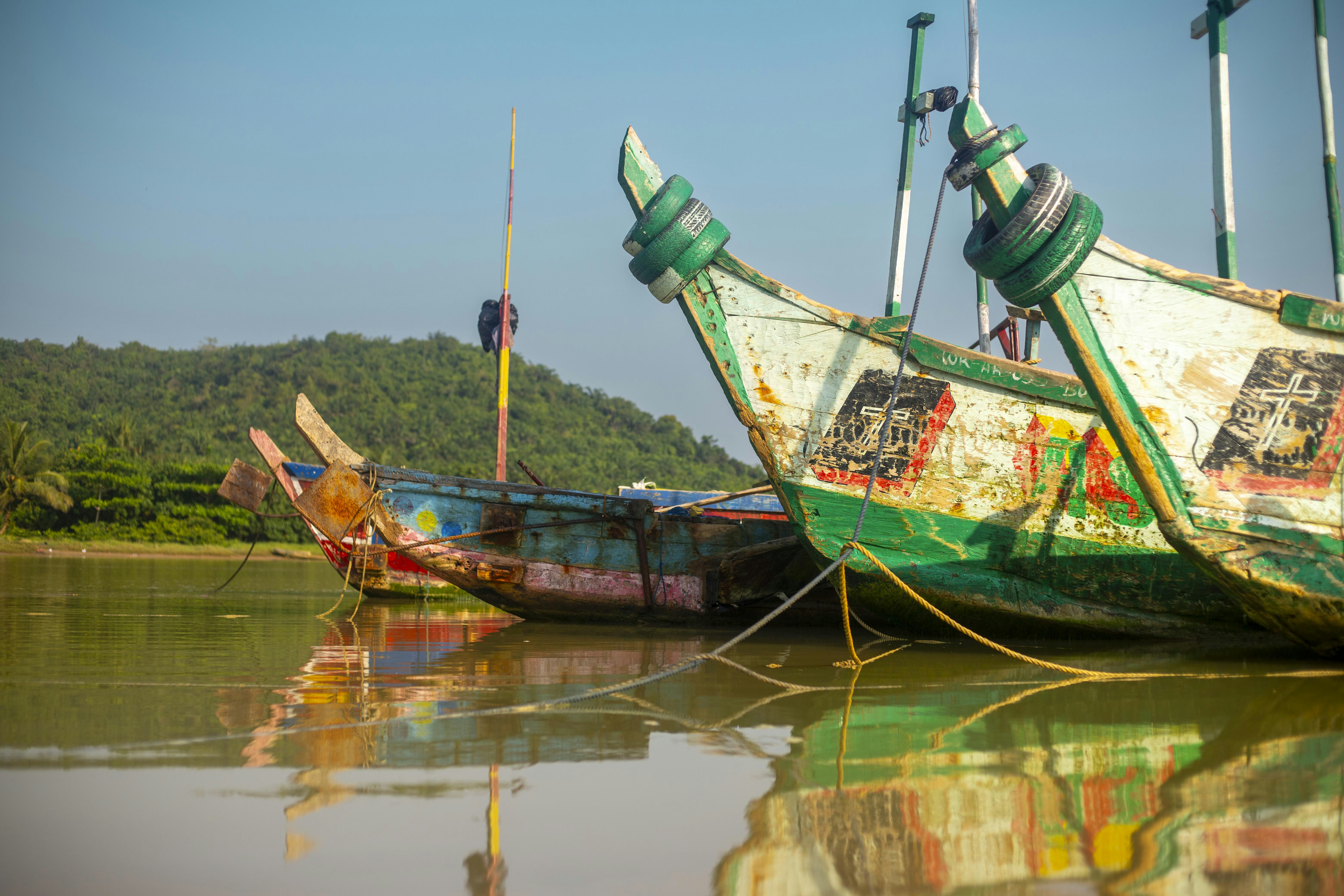 Un par de botes que están sentados en el agua foto – Imagen de Butre ...