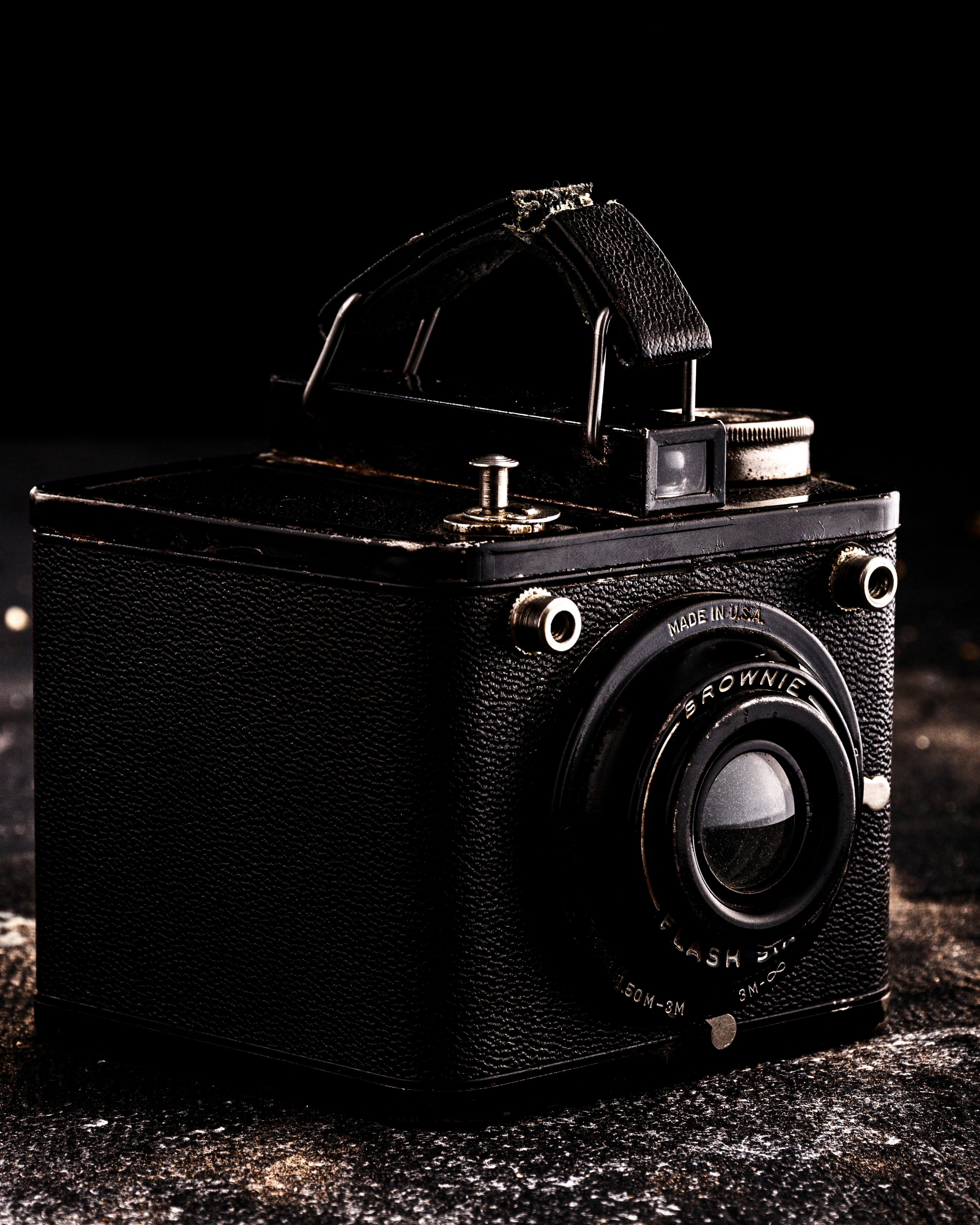 Time-Kept in Black: A Vintage Brownie Camera Resting on a Dusty Stage