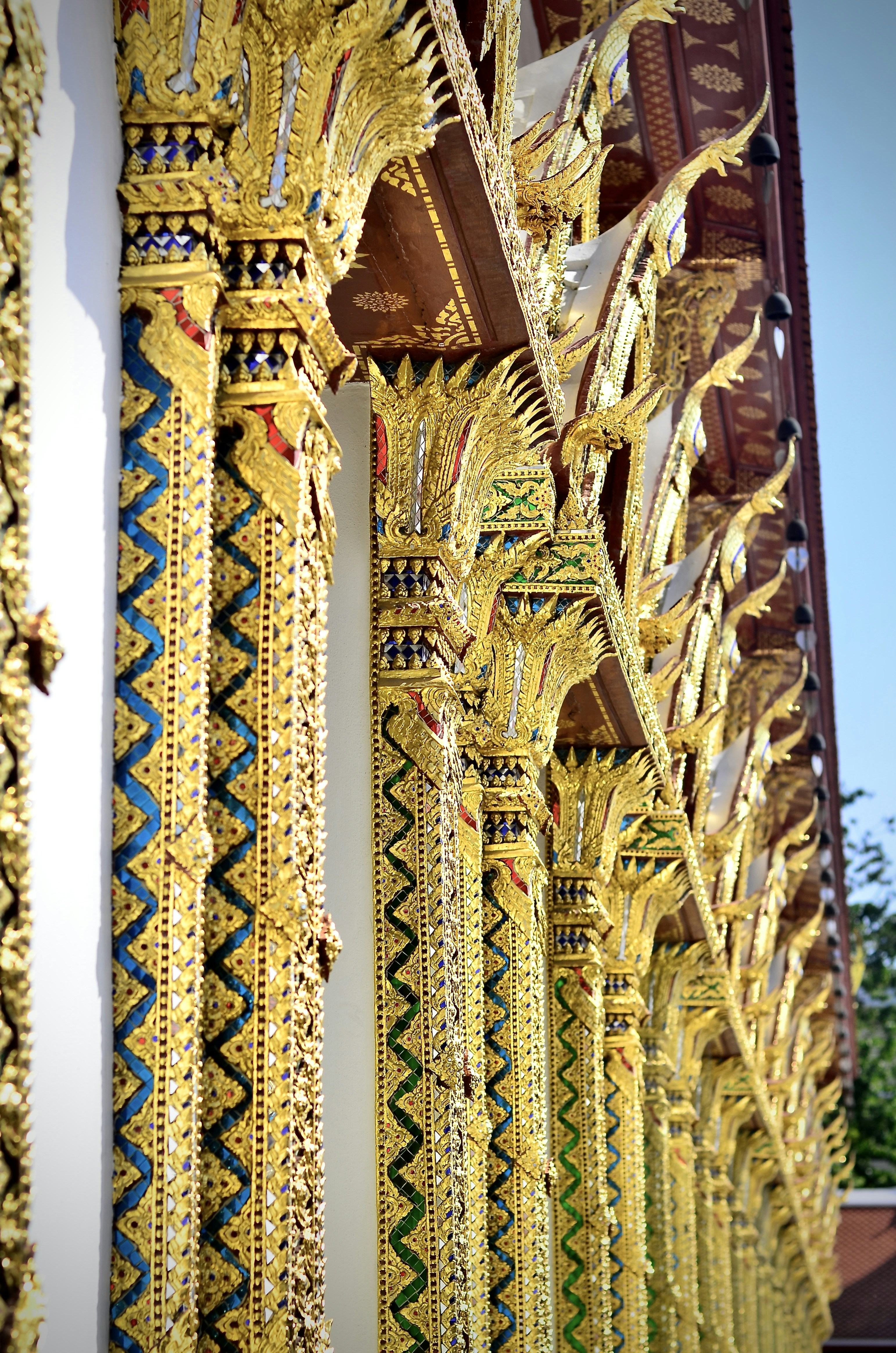 Receding Gilded Veranda: Dragon-Scale Columns at a Thai Temple
