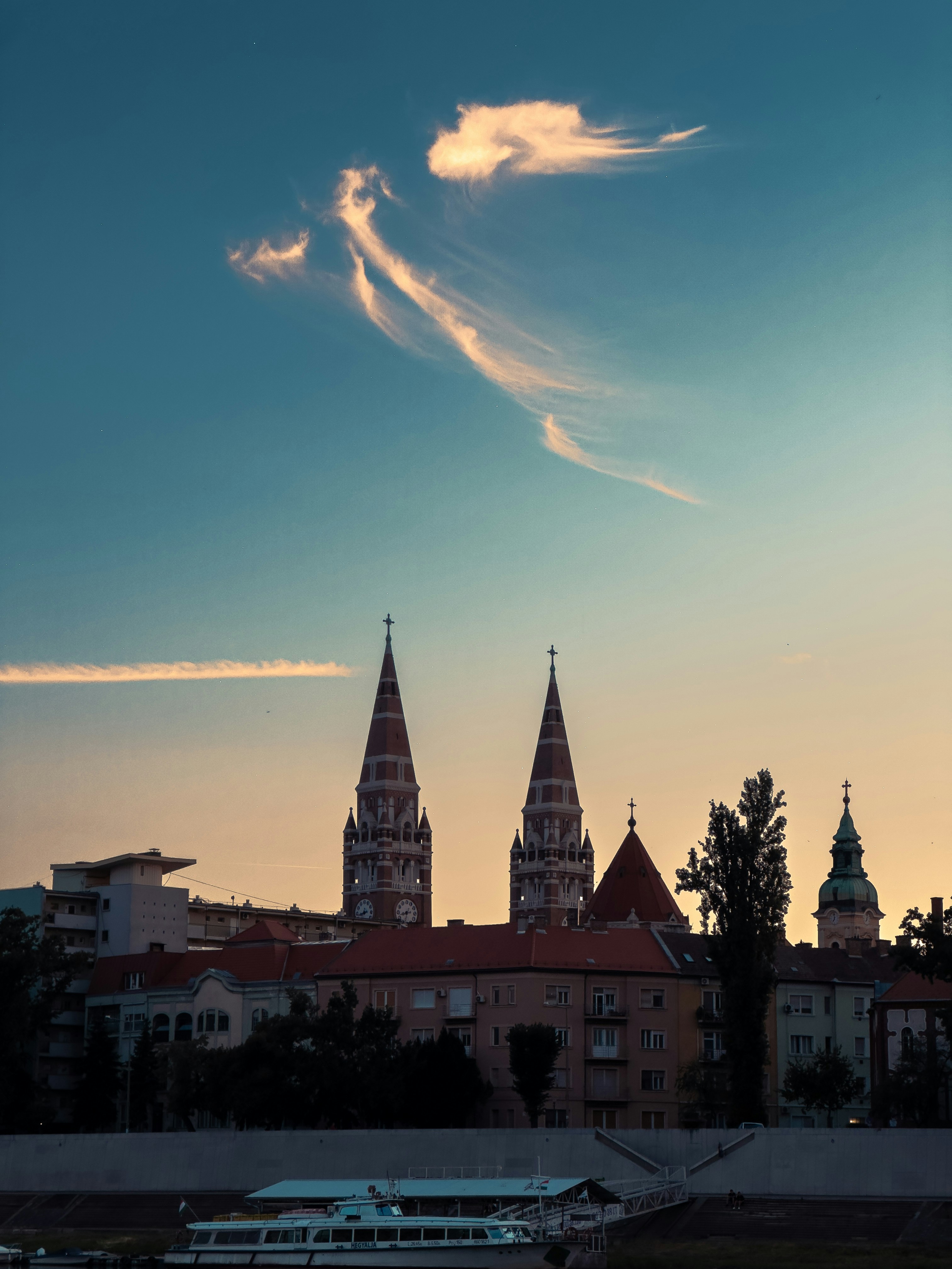 Twin Spires at Sunset: Riverside Silhouette Over the Calm Channel