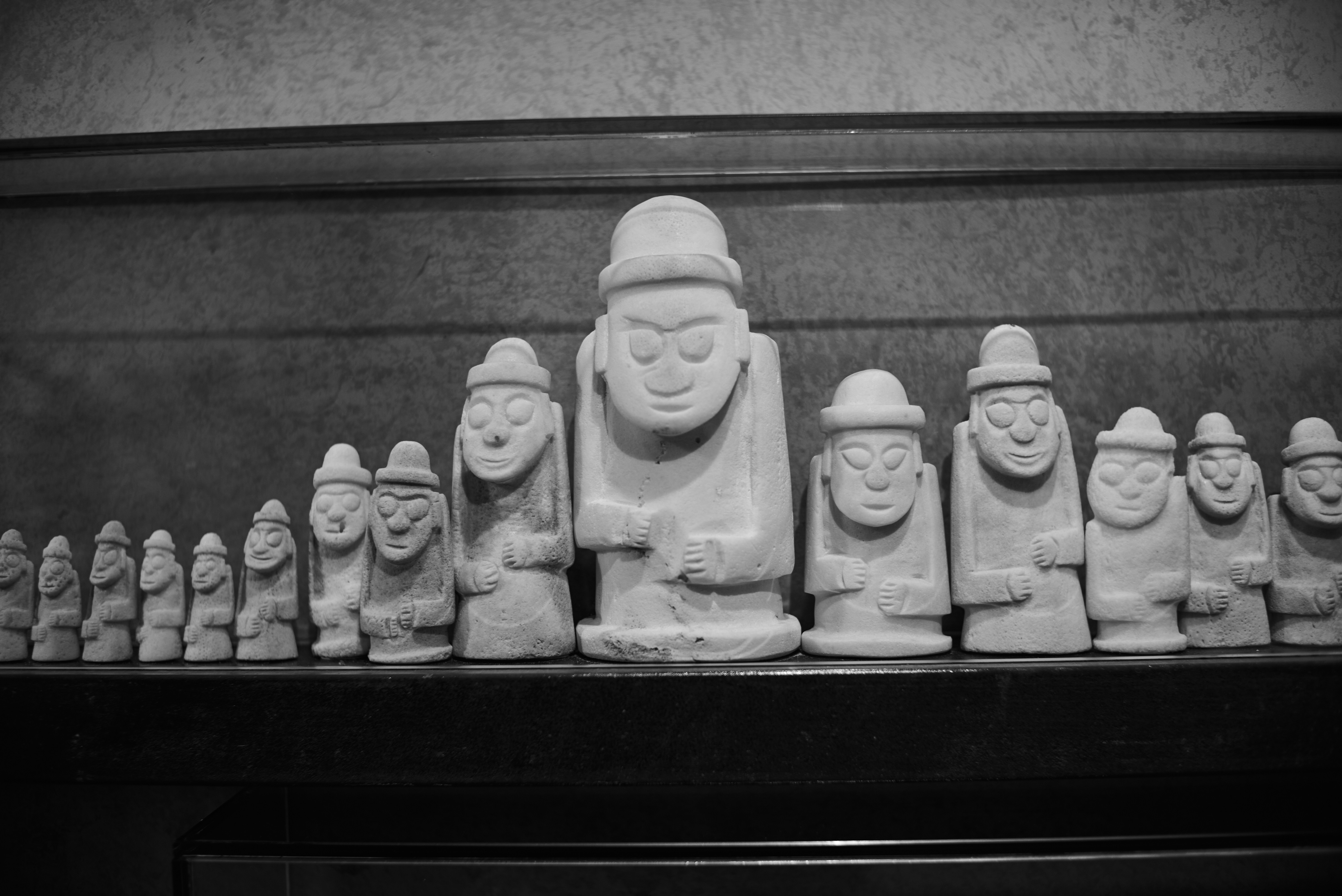 Centerpiece of Calm: The Prominent Monk Among Tiny Carved Companions