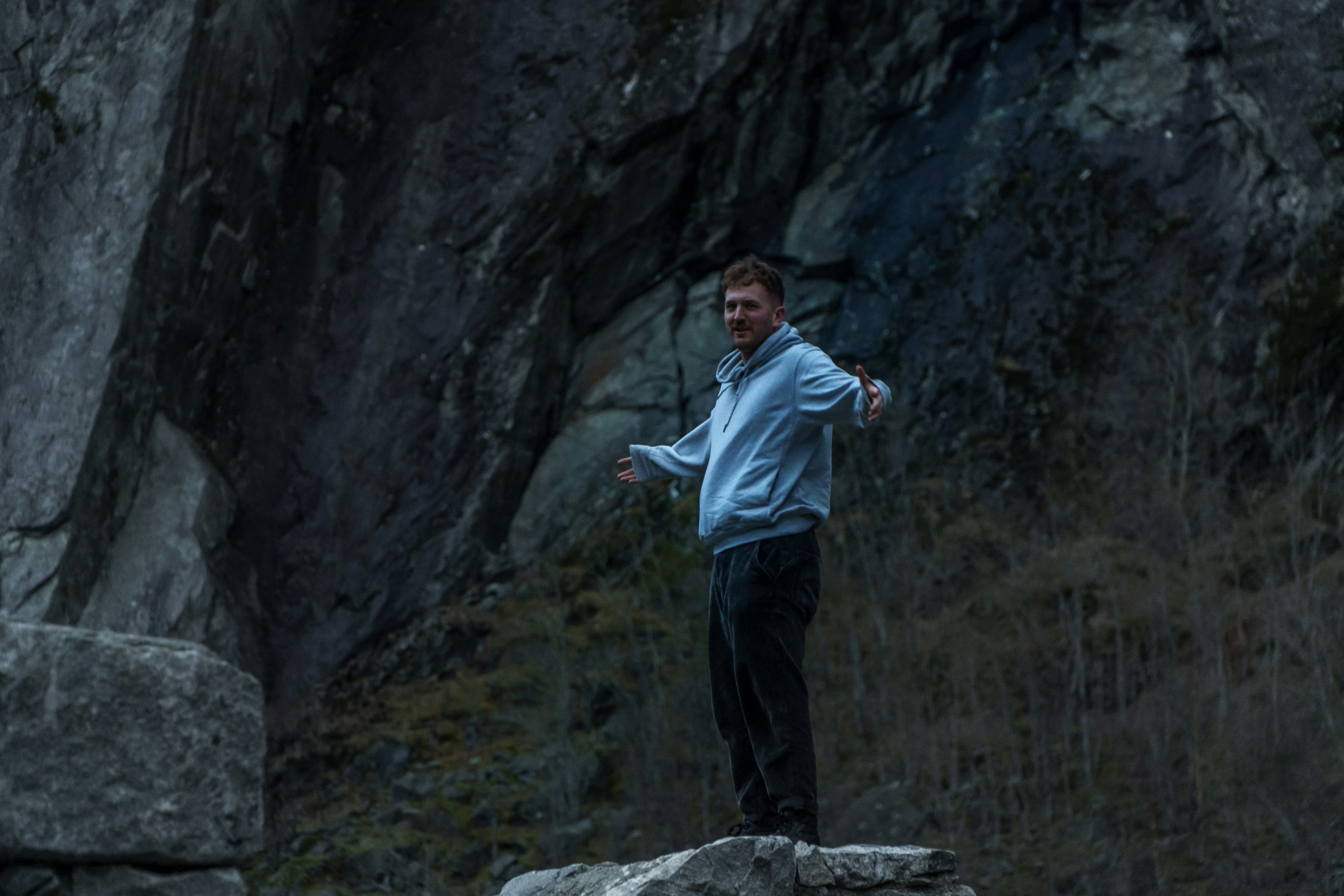 Stand on the Edge: A Quiet Stance Amid Cliffside Echoes