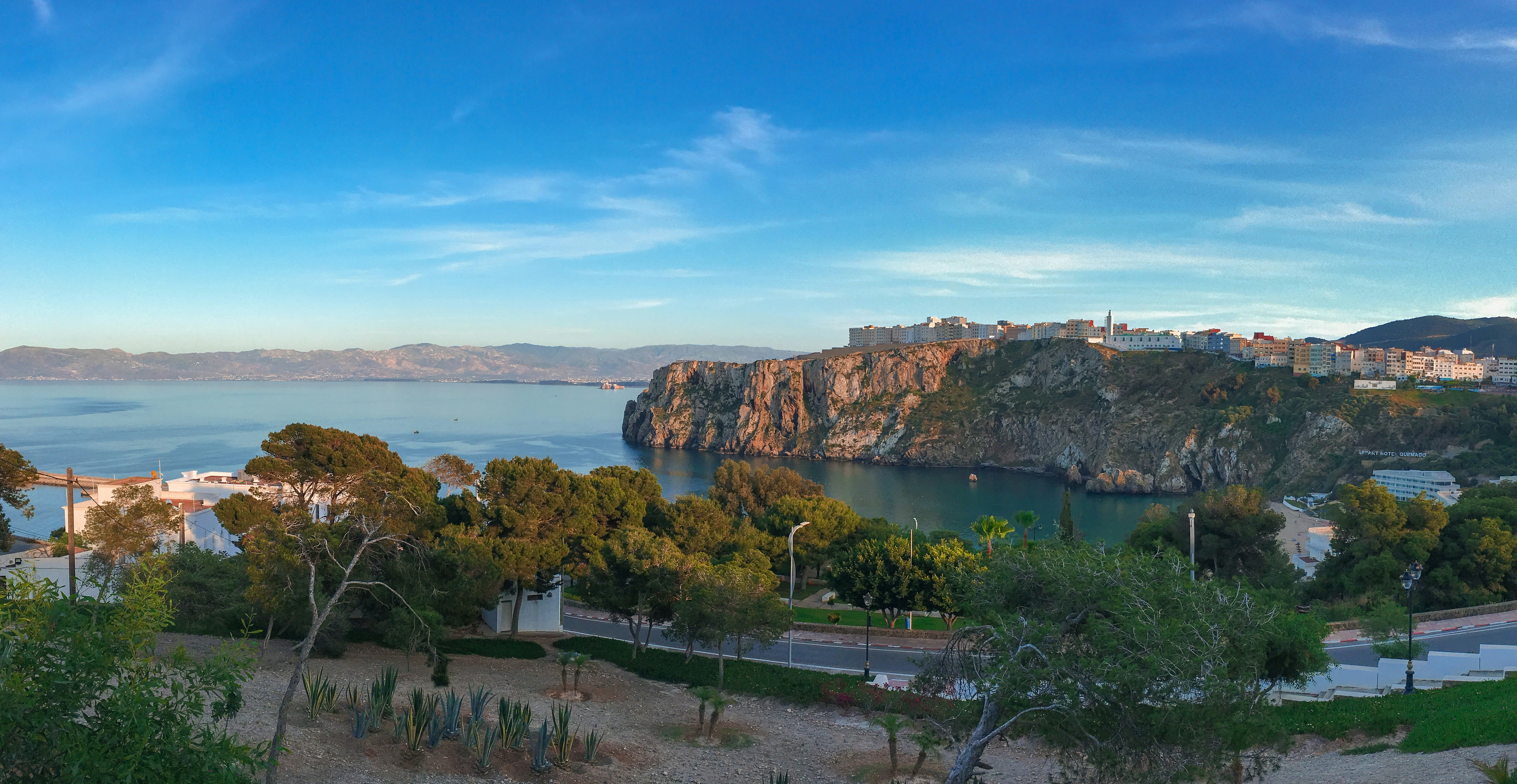 Cliffside Town Over a Tranquil Bay Beneath a Clear Azure Sky
