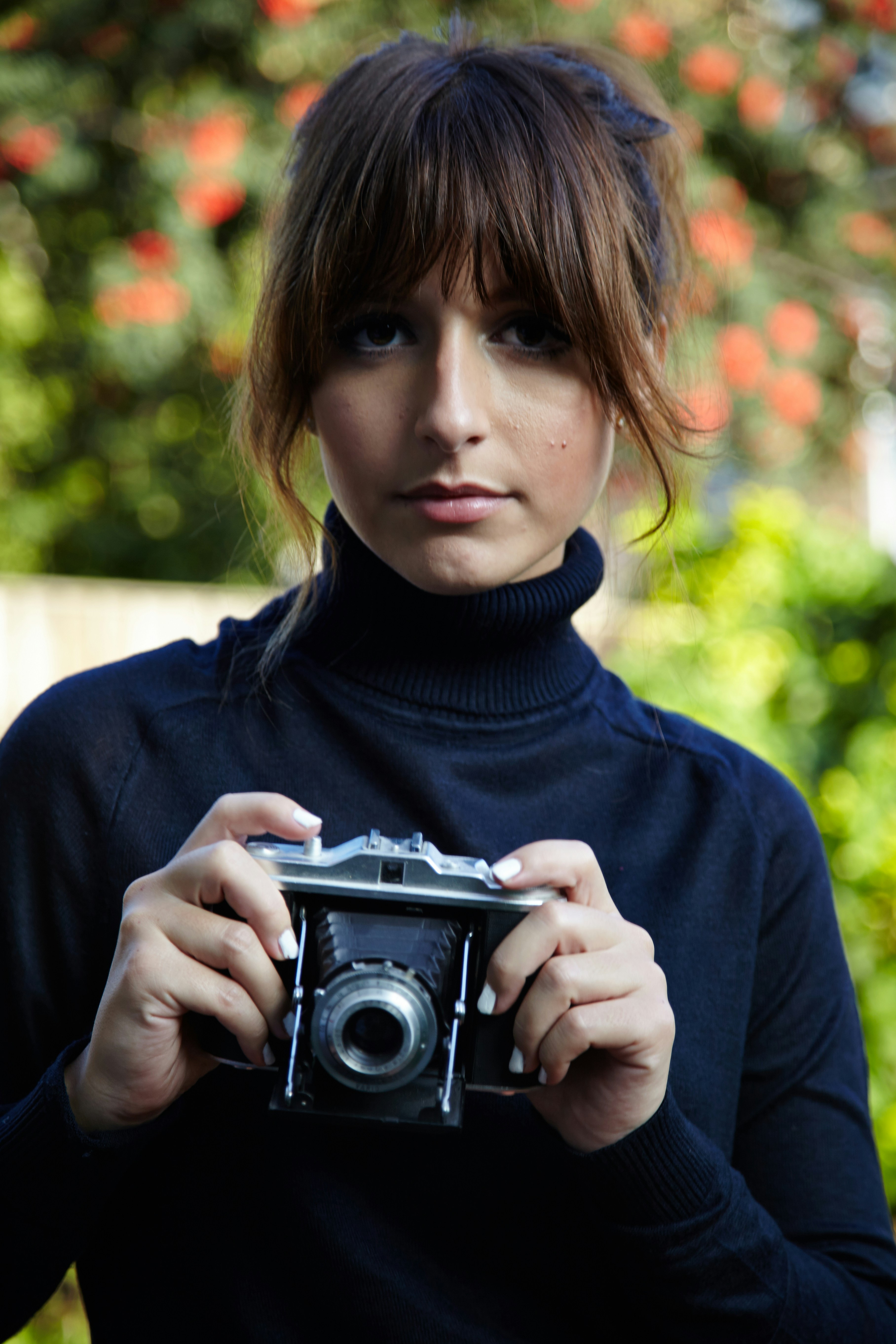 Soft Gaze with a Vintage Camera in a Garden Backdrop