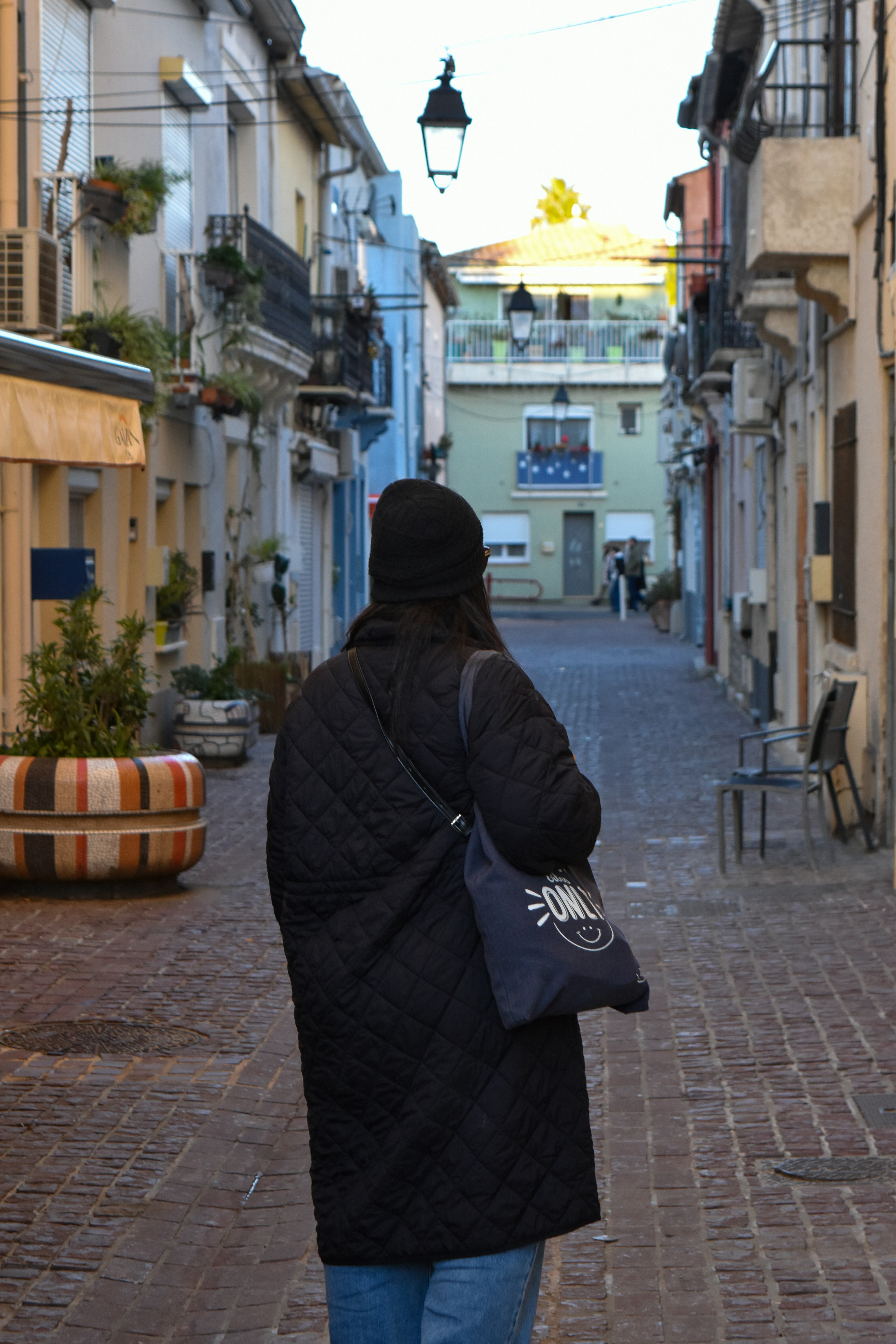 Whispering Cobblestones: A Quiet Portrait in a Colorful Calle