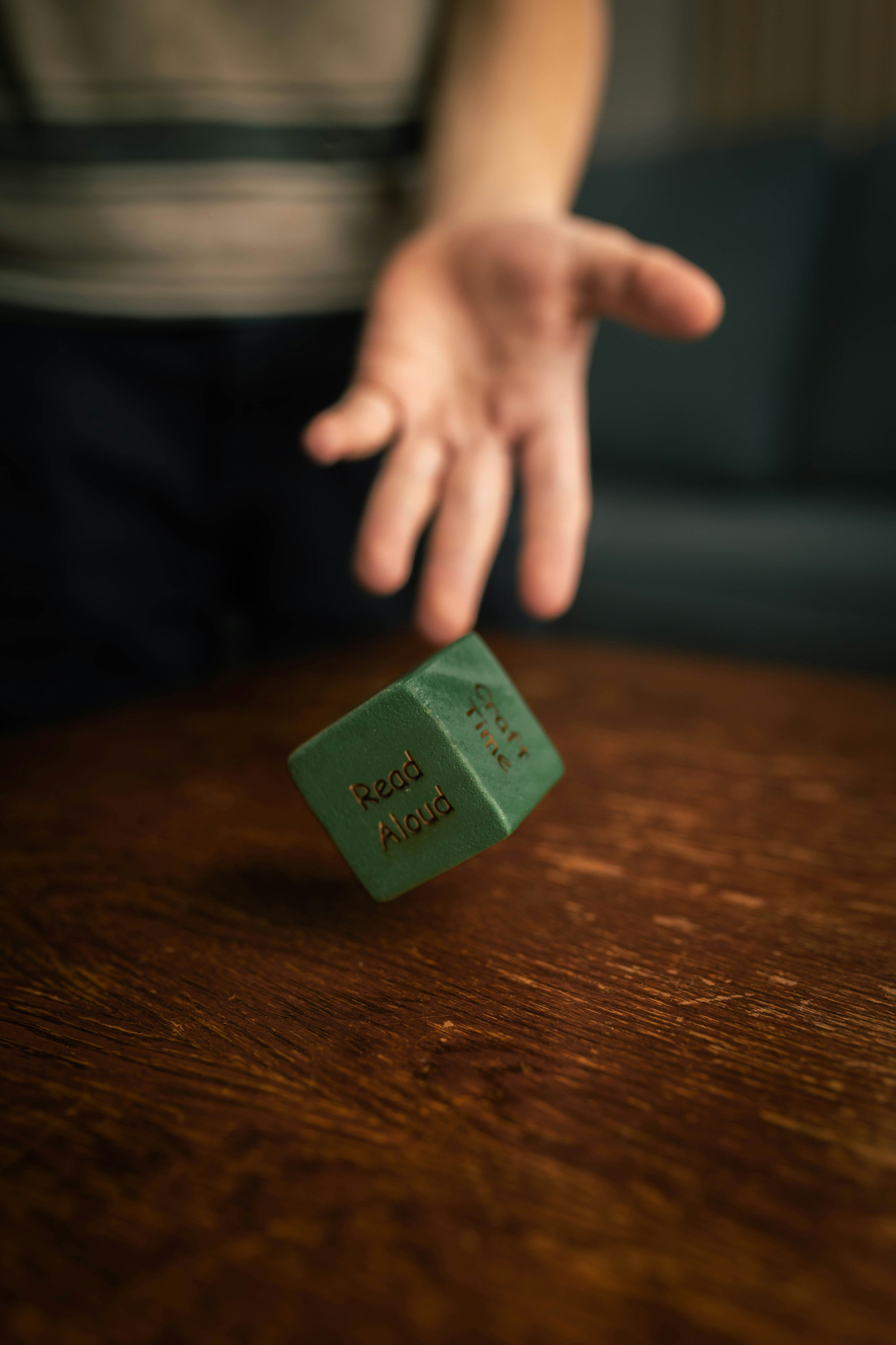 A person is throwing a dice on a table photo – Free Game,dice Image on ...