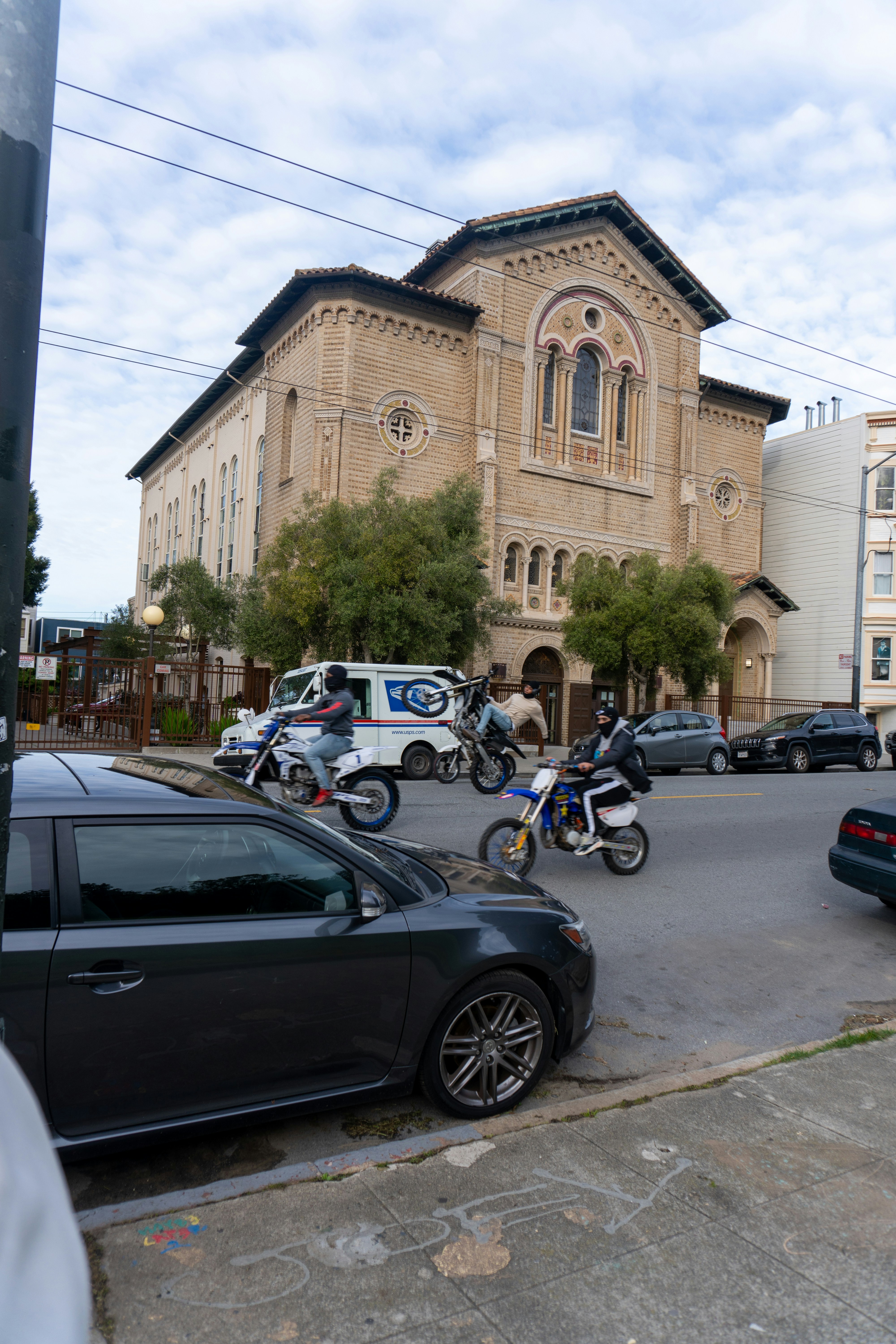 Arched Brick Facade Framed by a Busy Street Parade