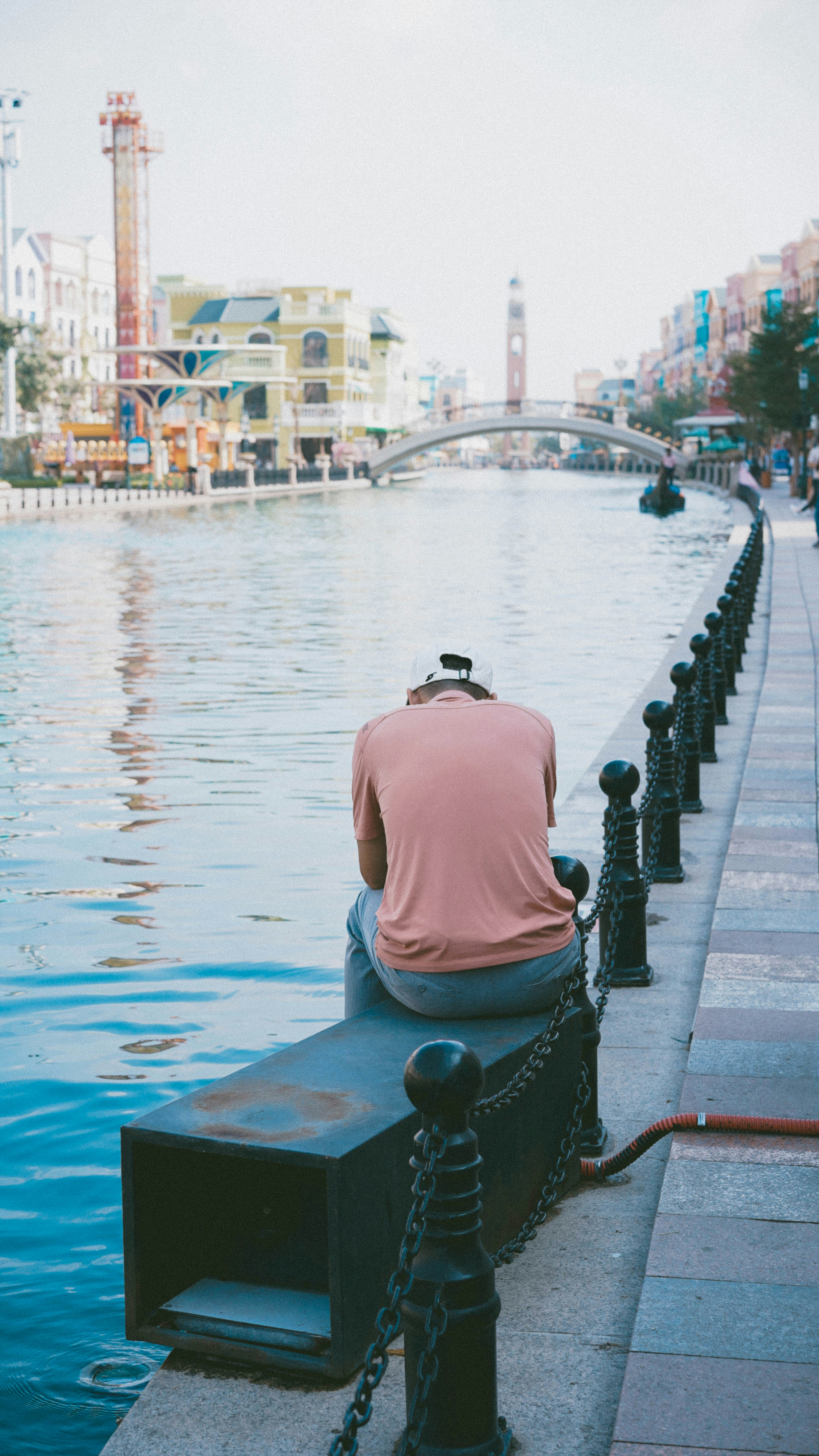 Whisper by the Canal: A Quiet Pause in a Colorful Cityscape