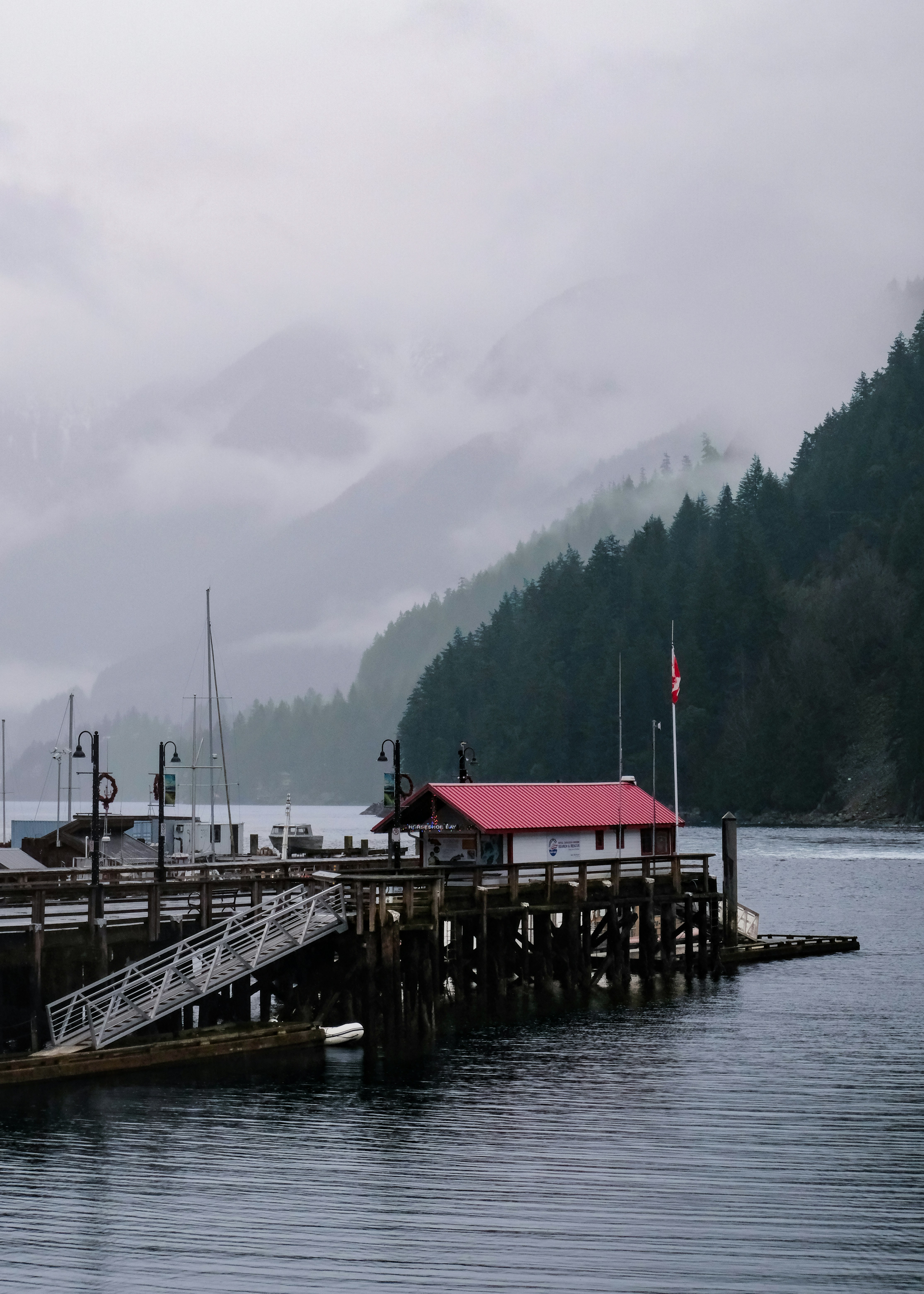 A dock with a boat and a red roof photo – Free Horseshoe bay Image on ...