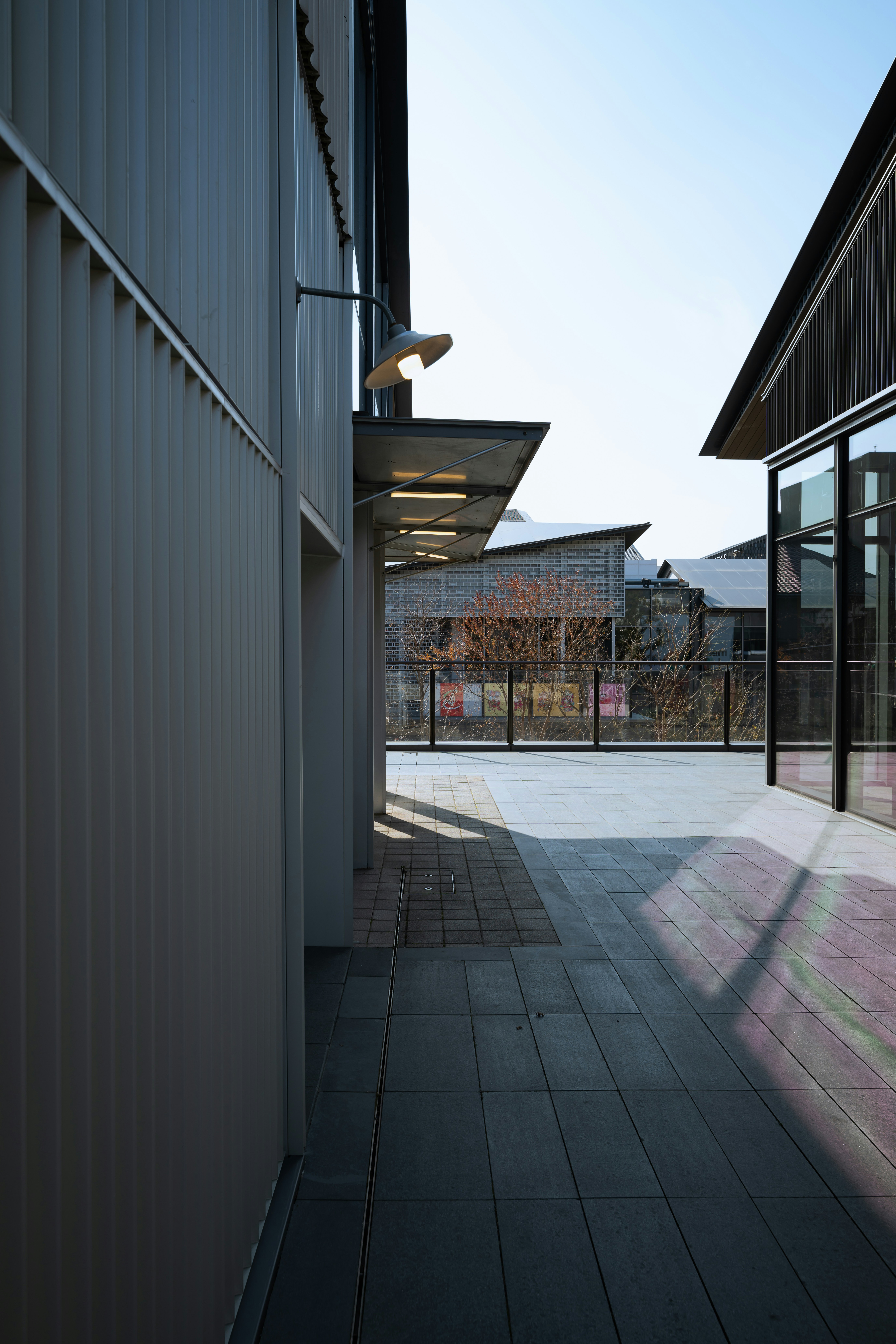 An empty walkway between two buildings on a sunny day photo – Free ...