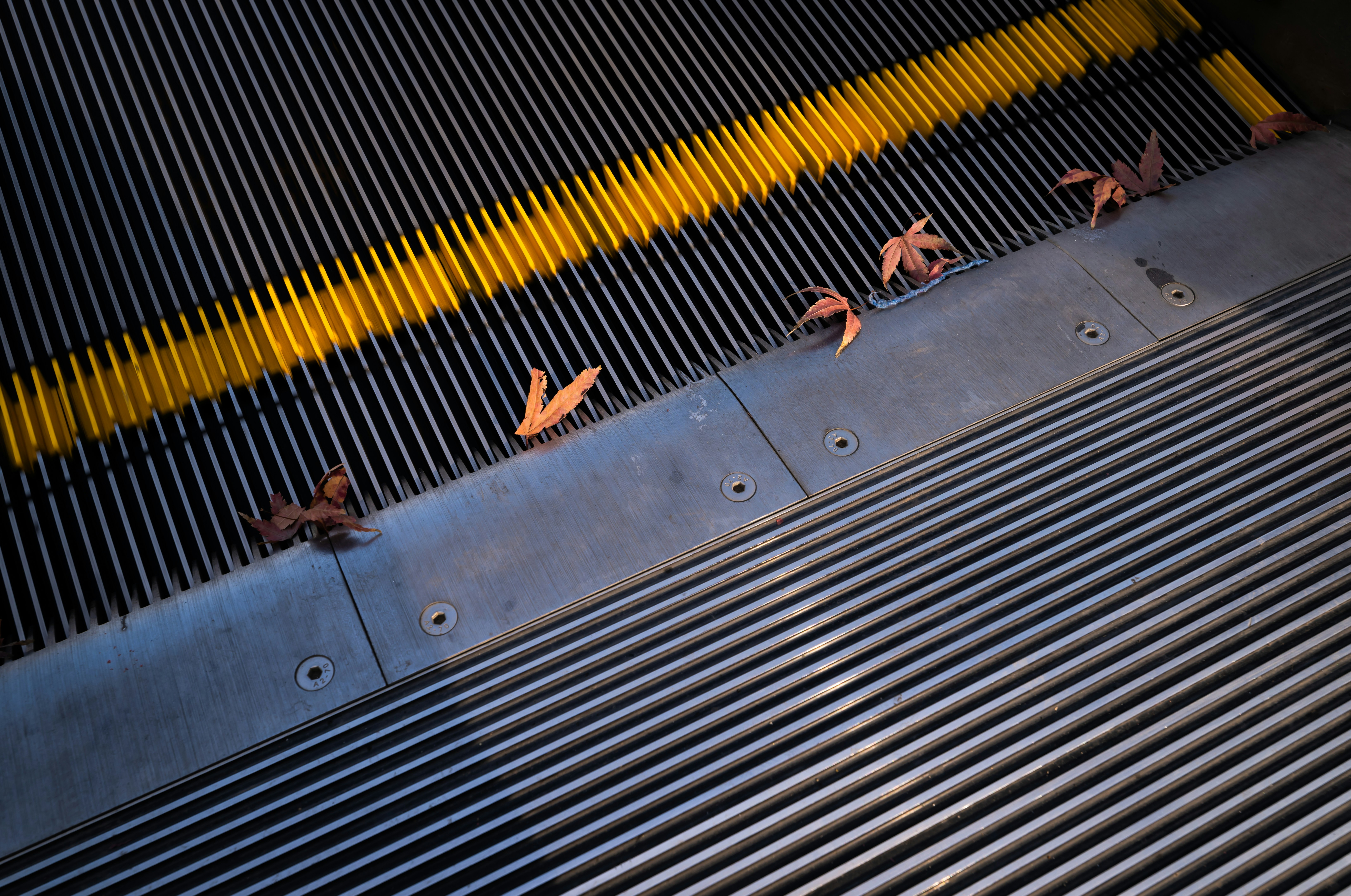 Orange Figures on a Blue Steel Grate: A Rhythmic Industrial Close-Up