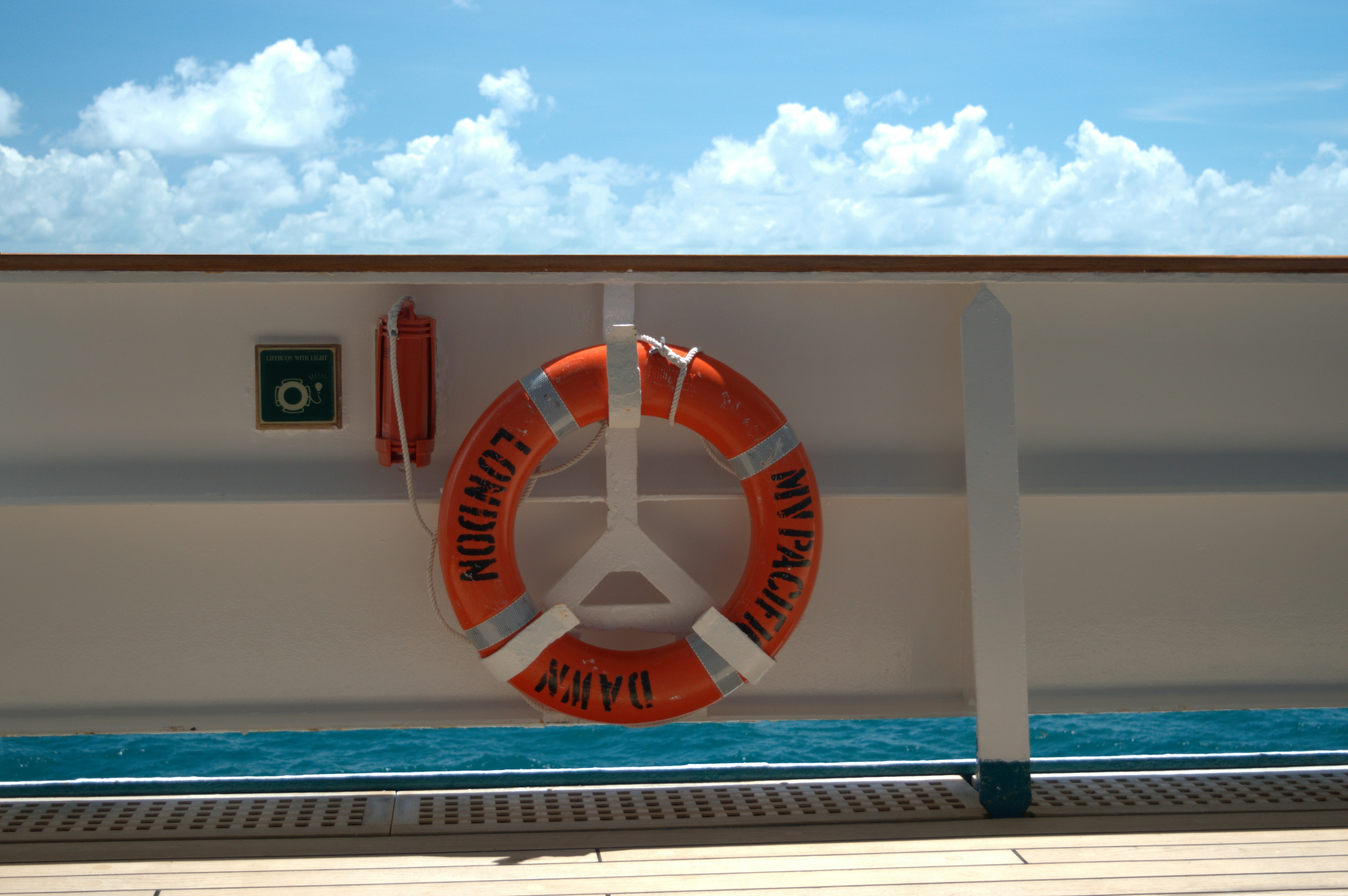 A life preserver on the side of a boat photo – Free Water Image on Unsplash