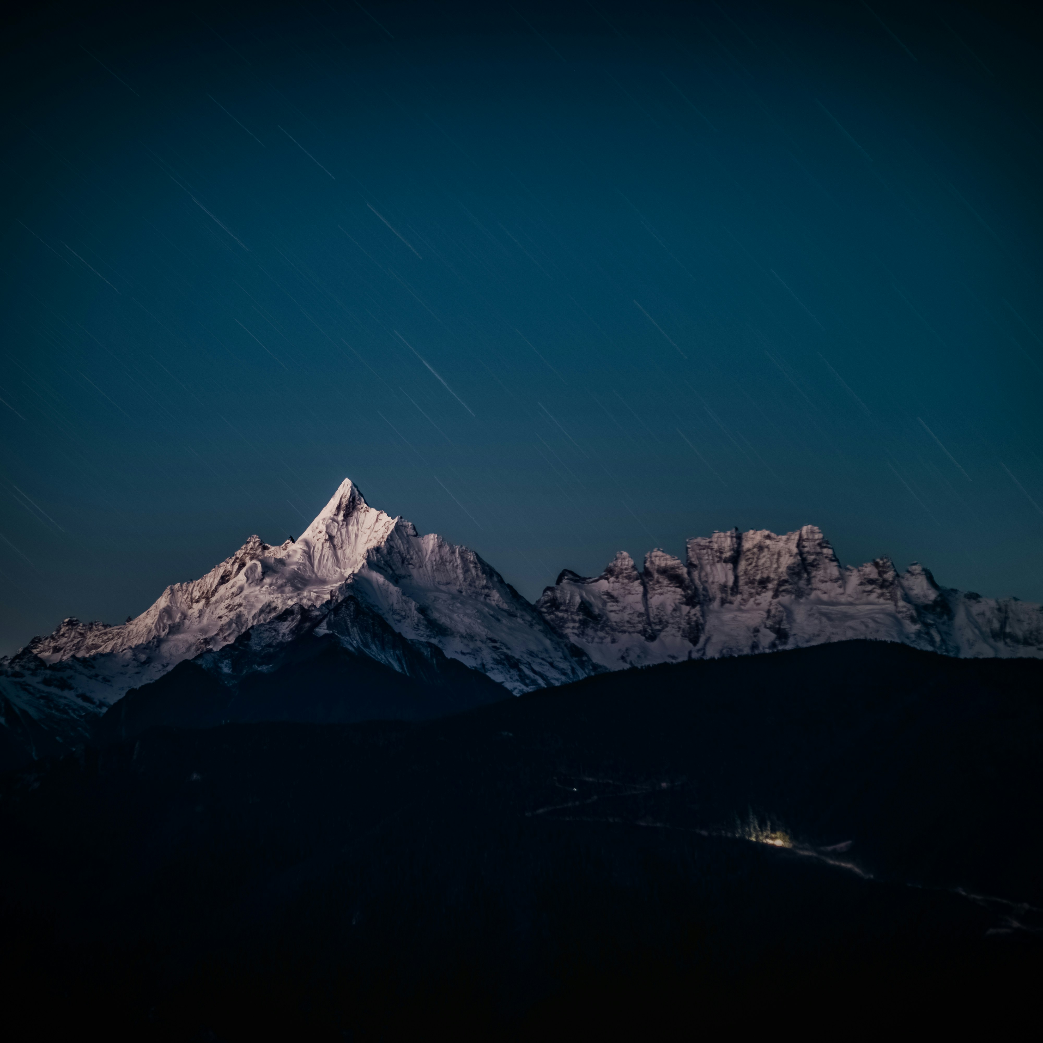 A view of a snow covered mountain at night photo – Free Xianggelila ...