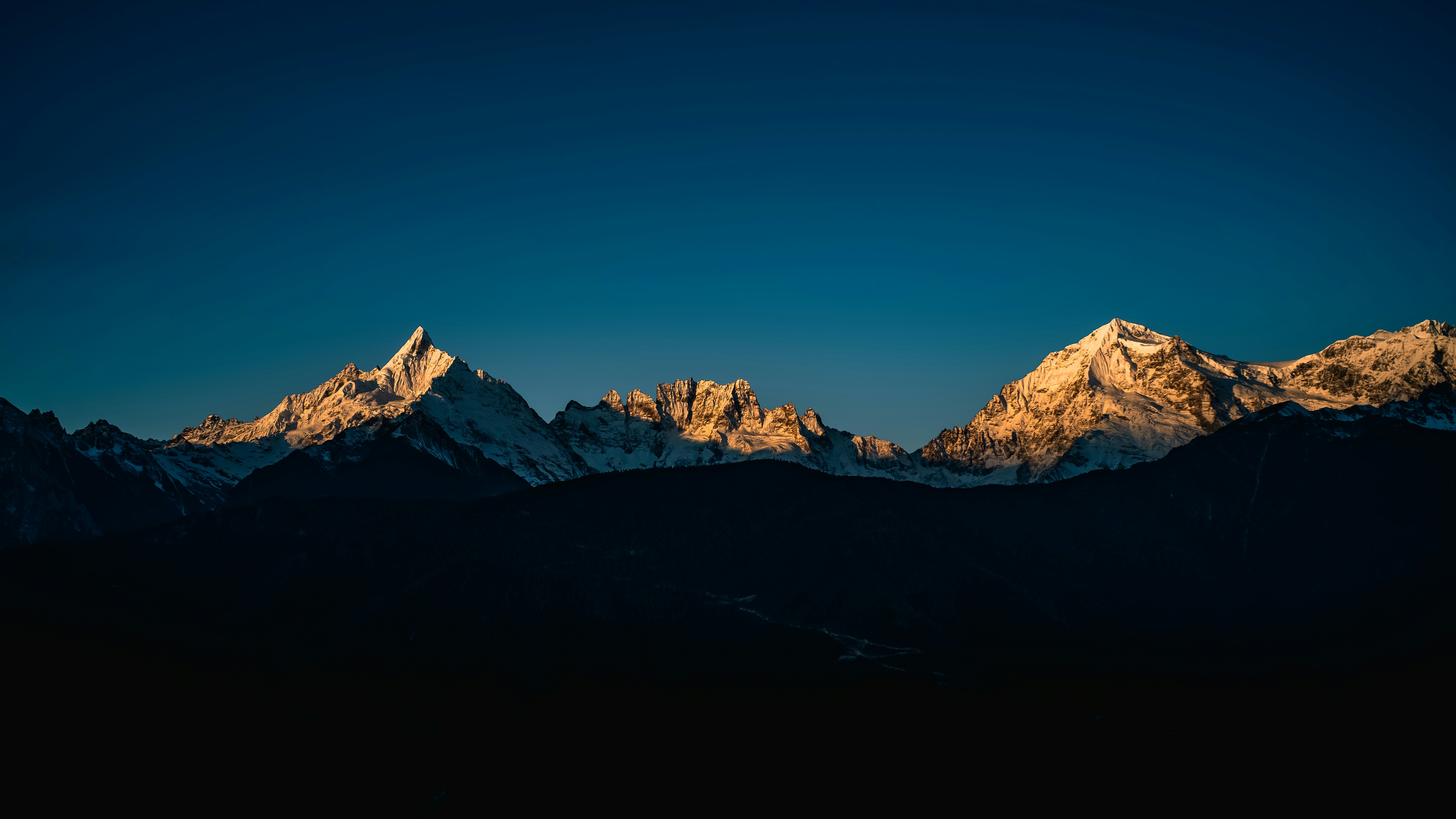 A view of a mountain range at night photo – Free Xianggelila road Image ...
