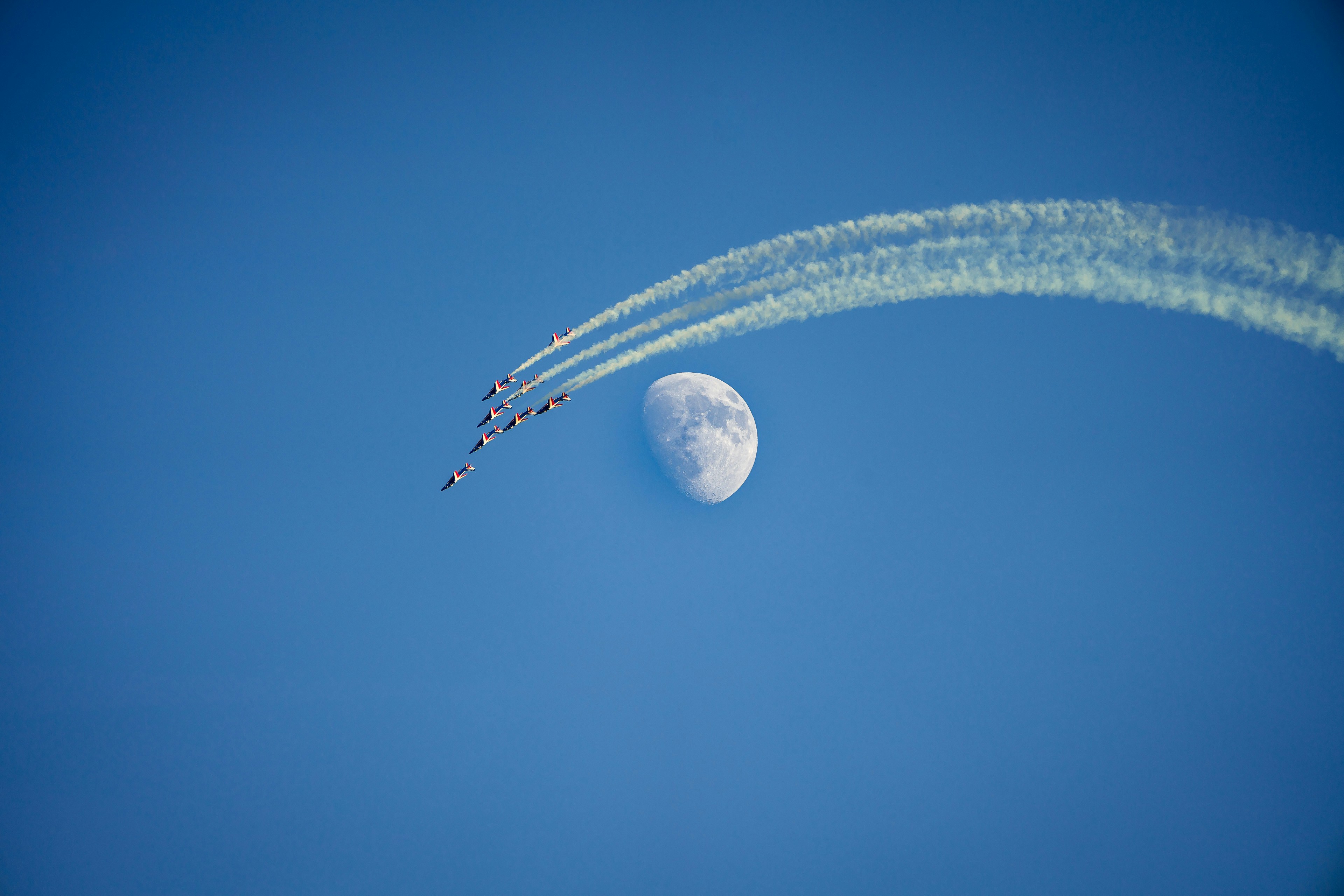 Two jets fly past the moon in a clear blue sky photo – Free Sky Image ...