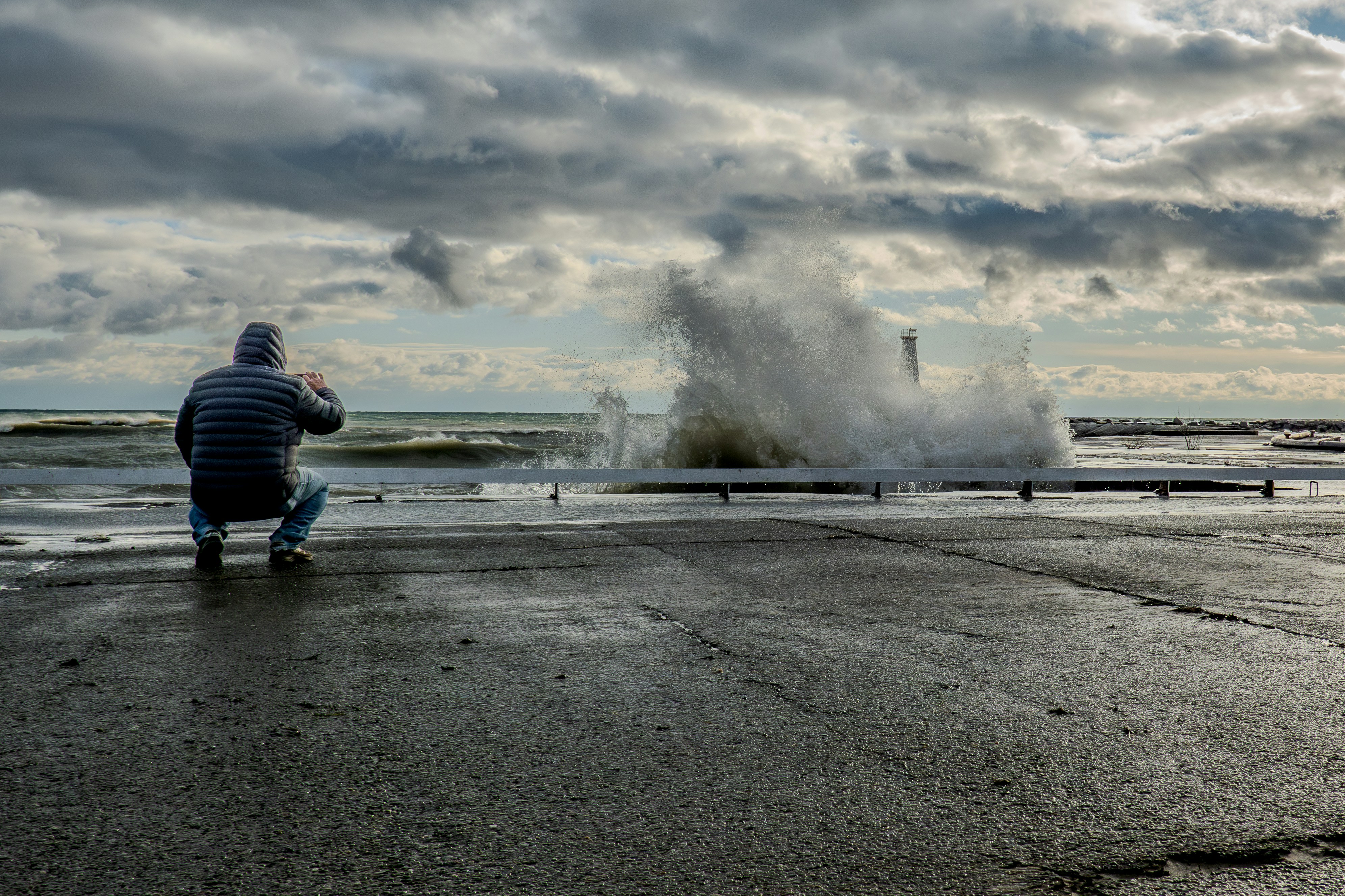Crouched at the Edge: Photographer Traps a Wave's Surge Along a Weathered Sea Wall