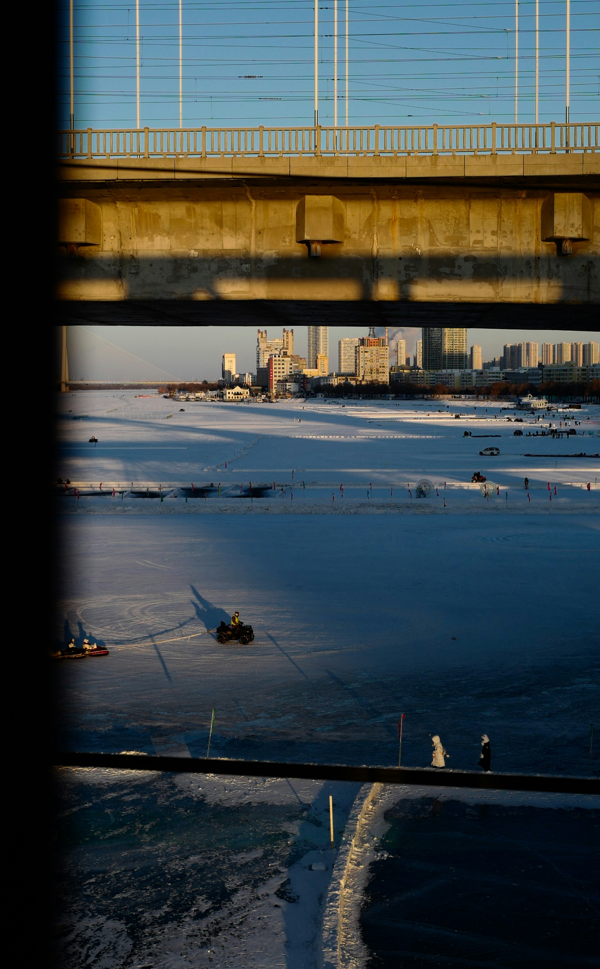 A bridge over a body of water with buildings in the background photo ...